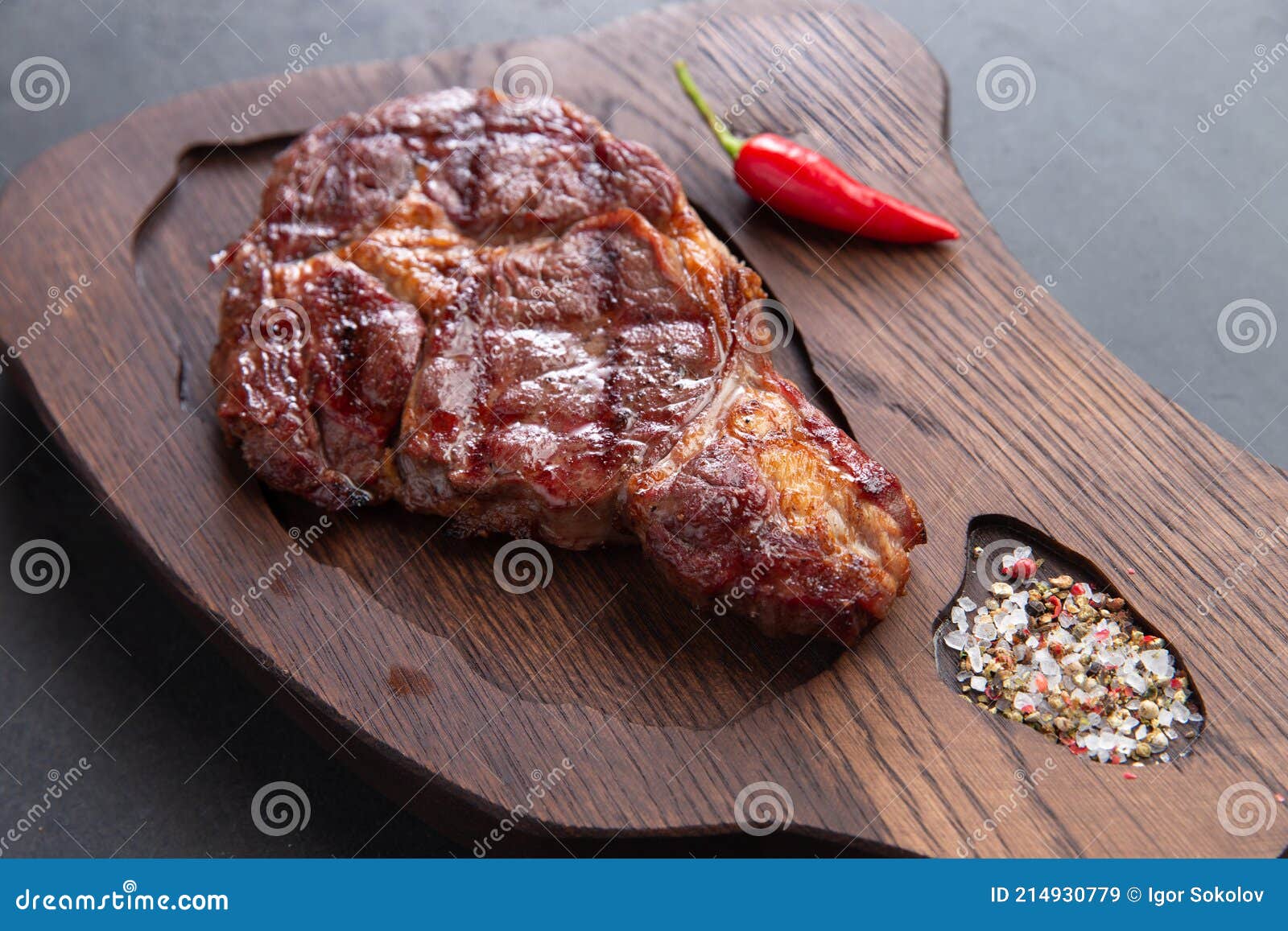 Steak on a wooden stand stock image. Image of cooked - 214930779