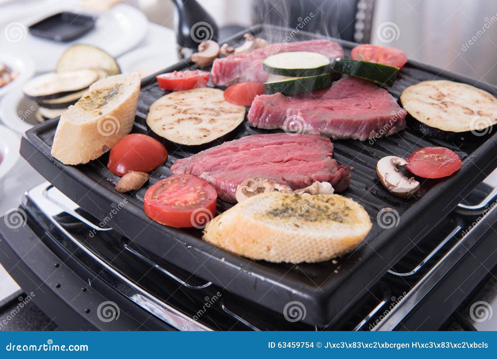 Steaks, Garlic Bread and Mushrooms on the Raclette Cooking Stock Photo ...