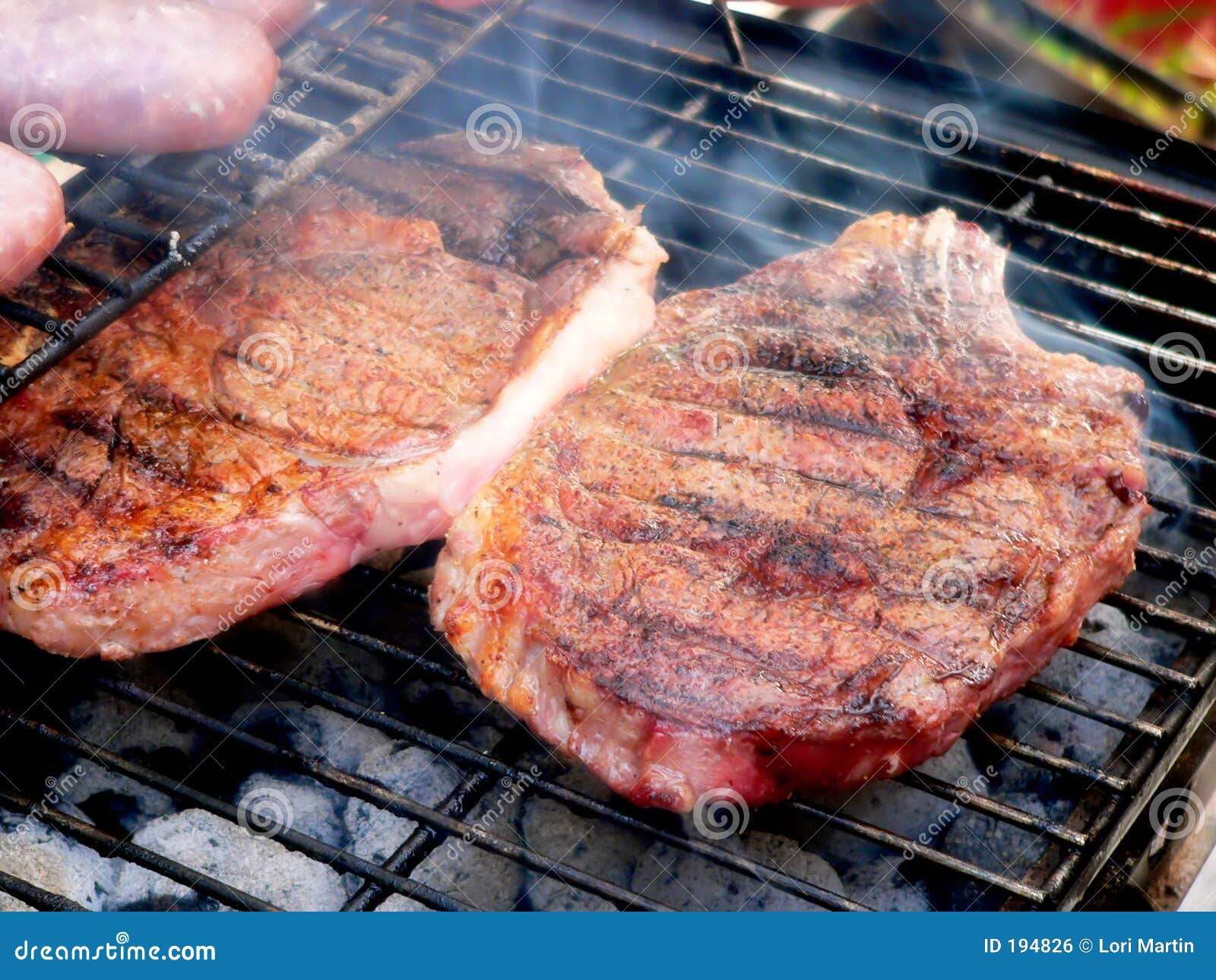 Steaks on Grill stock photo. Image of summer, ribeye, sausage - 194826