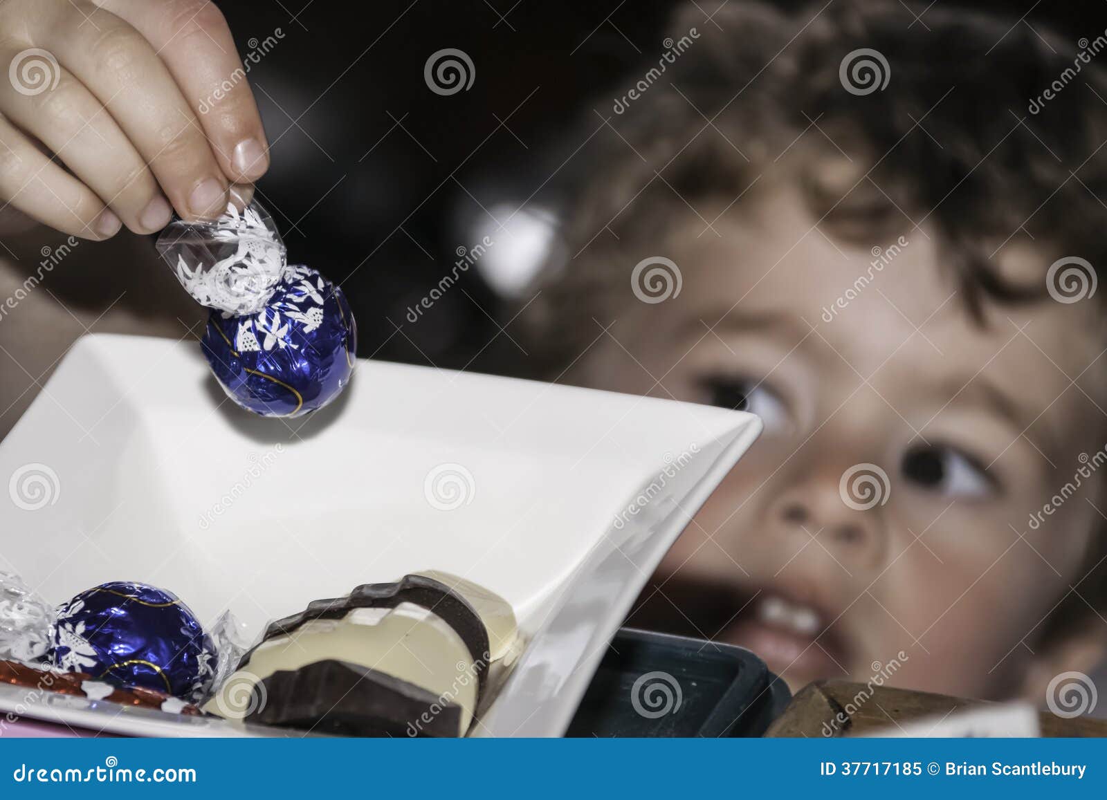 Stealing a chocolate. stock image. Image of adorable - 37717185