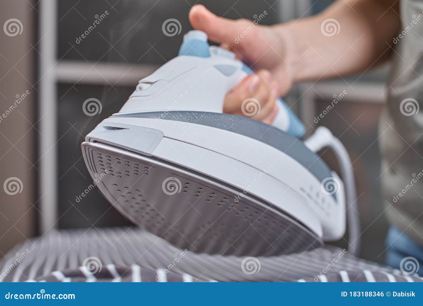 Steam Boost on the Modern Iron. Woman Ironing Clothes with Modern Iron ...