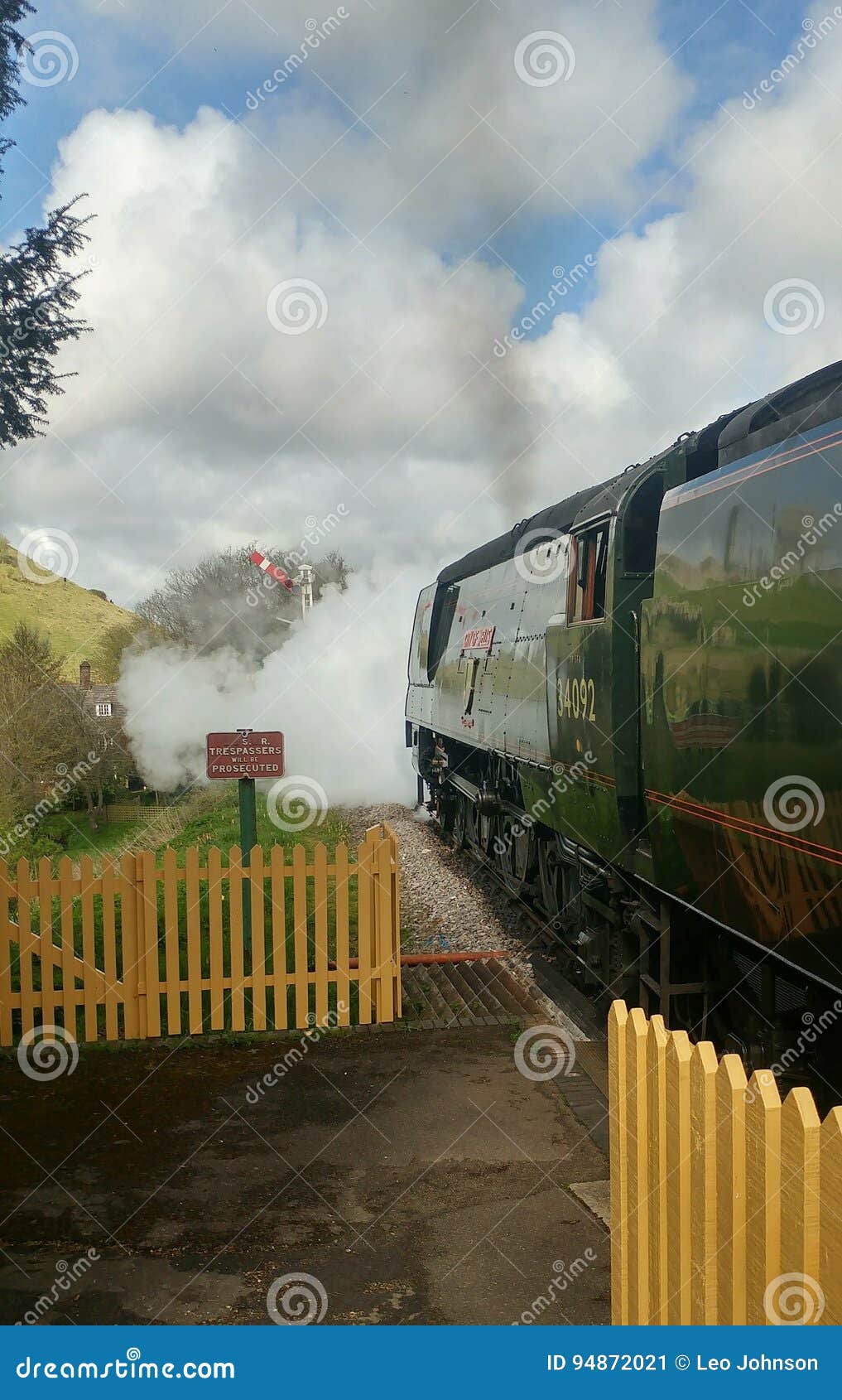 A Green Steam Train On Railway Tracks Editorial Photo | CartoonDealer ...