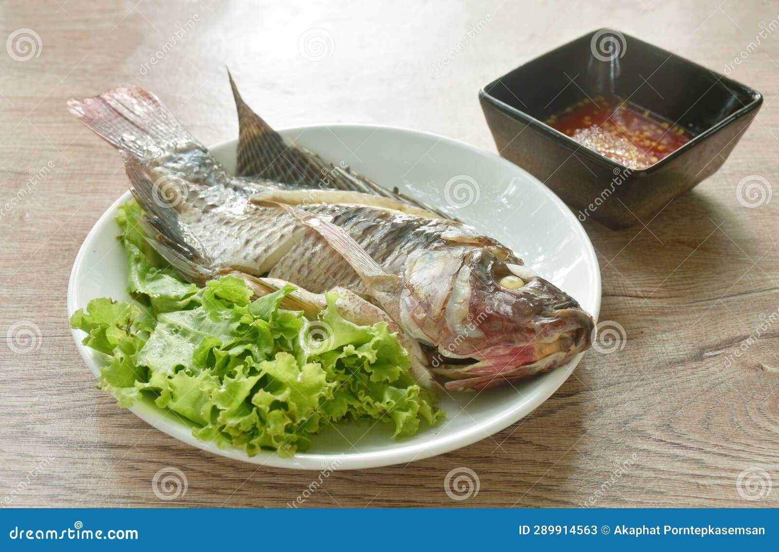 Steamed Mango Fish with Lettuce Dipping Spicy Sauce on Plate Stock ...