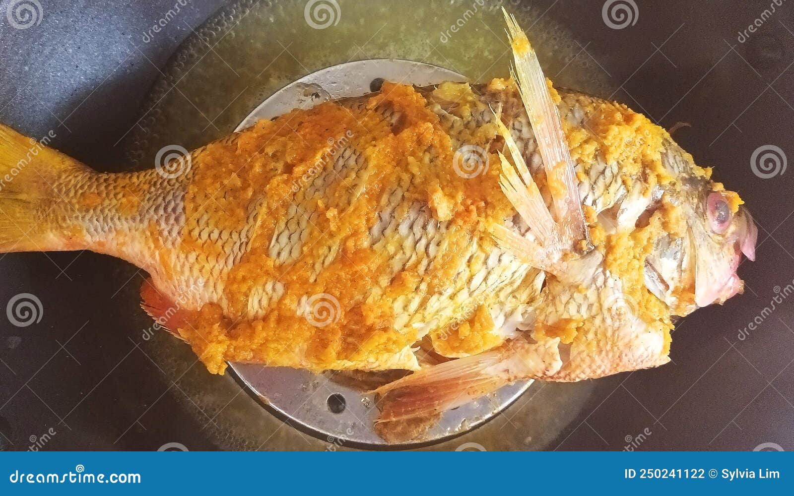 Steaming Fish Caesionidae with Minced Tumeric Seasoning. Stock Photo ...