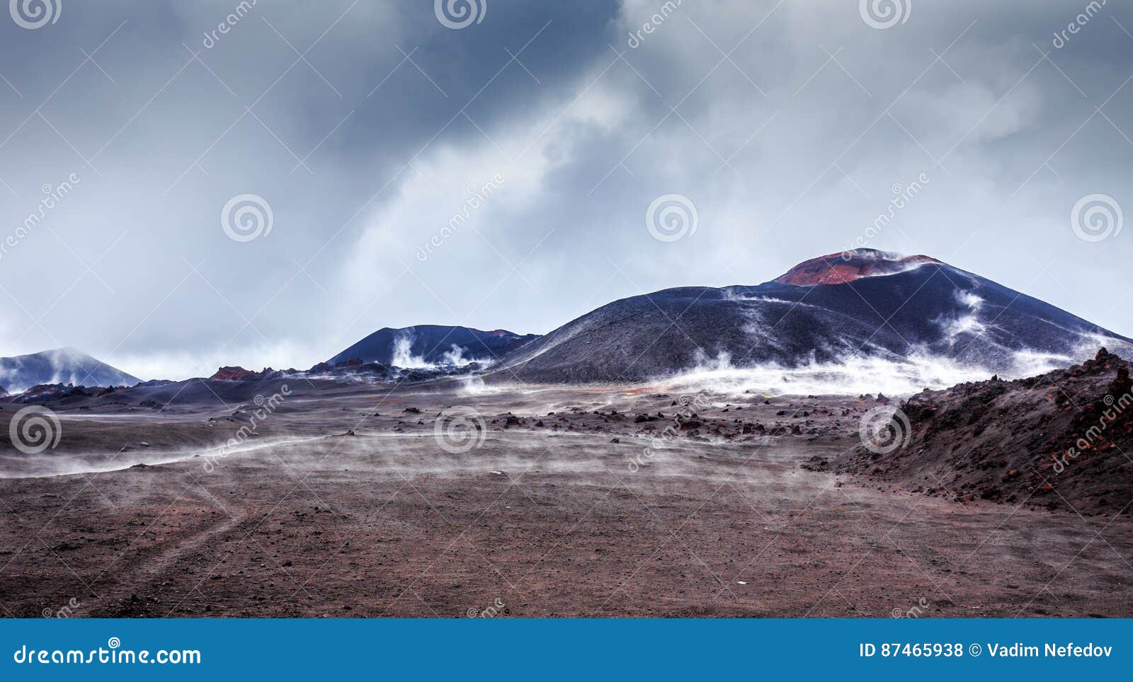 Steaming Lava Valley with Volcanoes Craters in the Background Stock ...