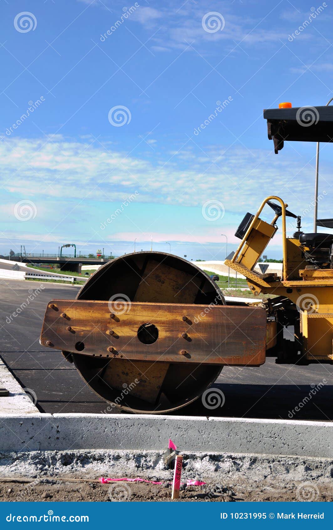 Steamroller And Road Construction Workers At Road Construction Site ...