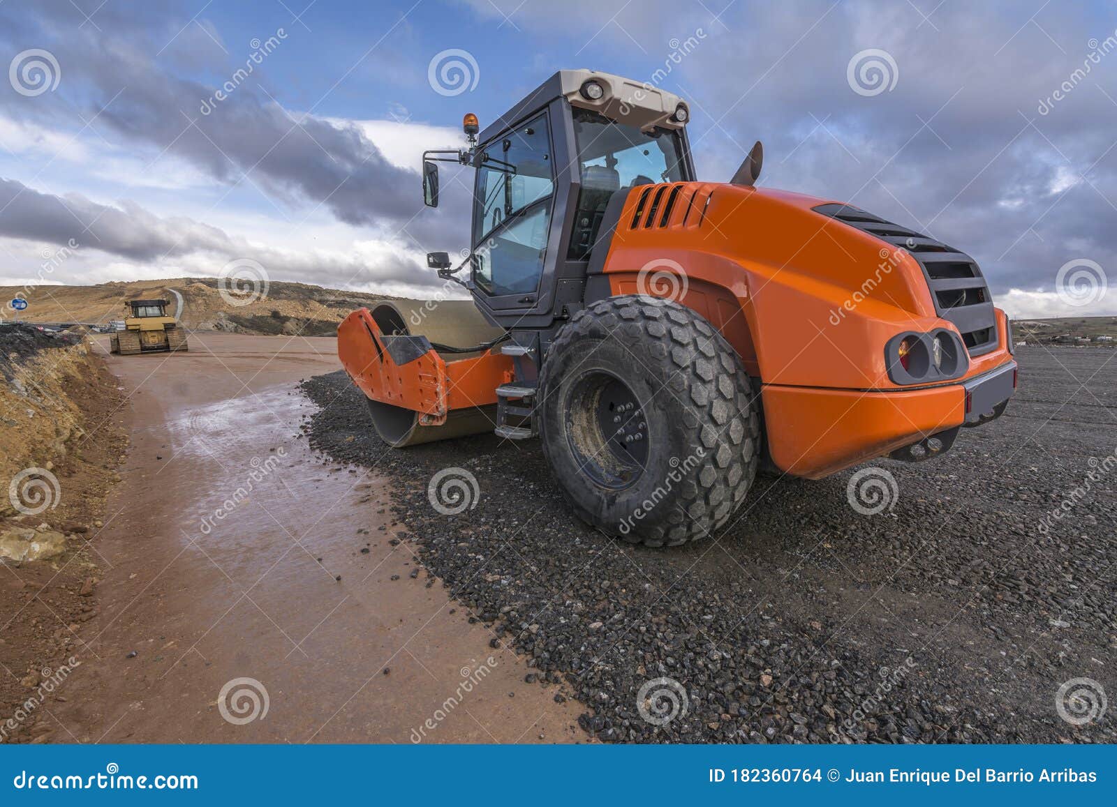 Steamroller And Road Construction Workers At Road Construction Site ...