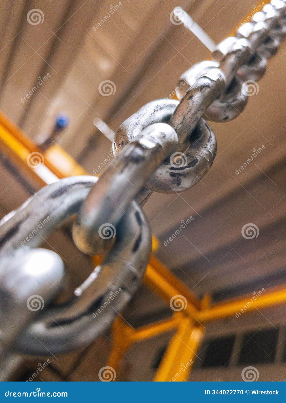 Steel Chain Suspended from Mechanical Crane in an Industrial Setting ...