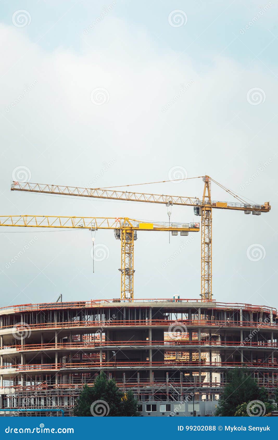 Steel Frames of a Building Under Construction, with Two Tower Cranes on ...