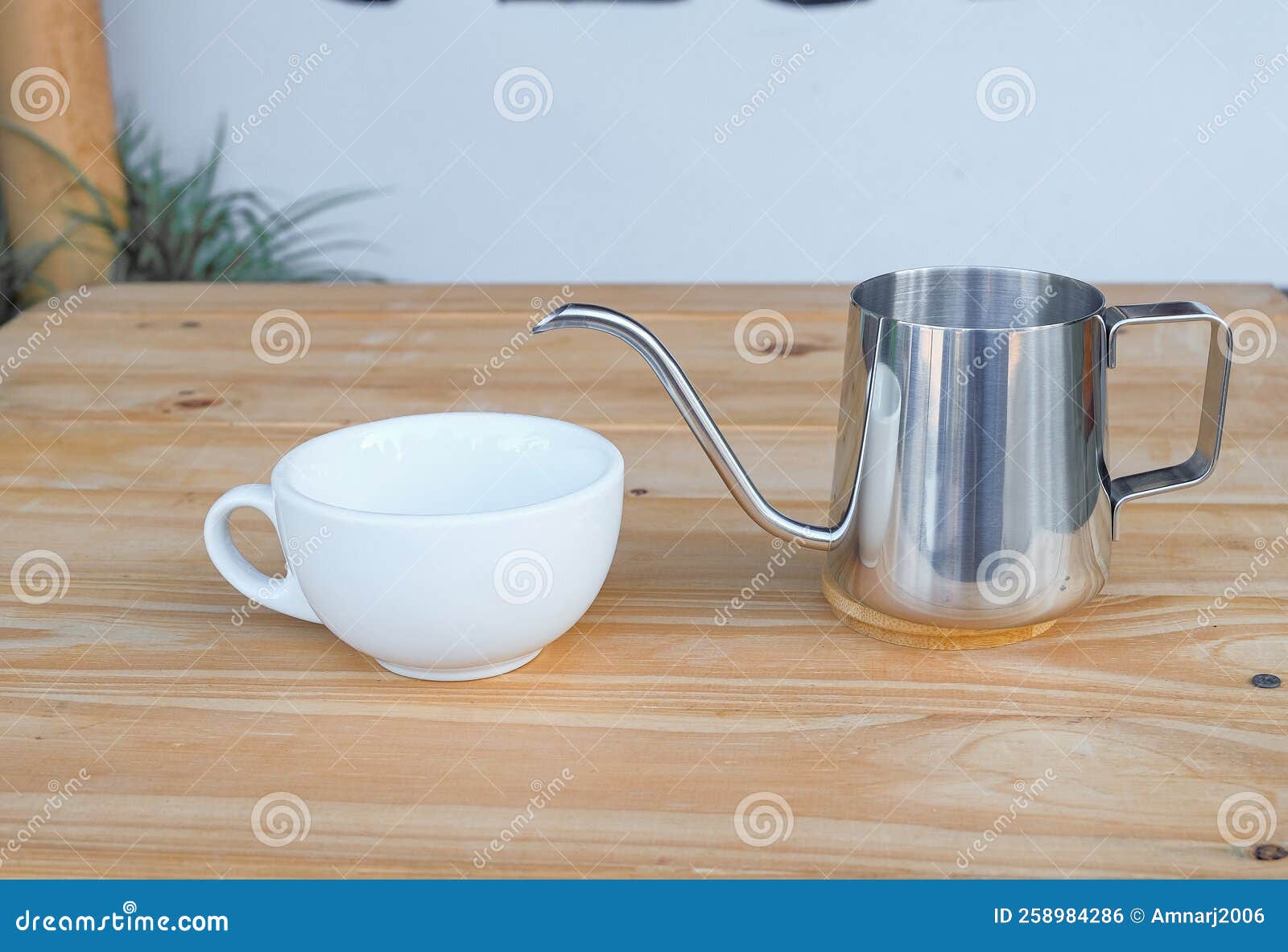 Steel Long Spout Drop Kettle on Wood Stock Photo - Image of hold, steel ...