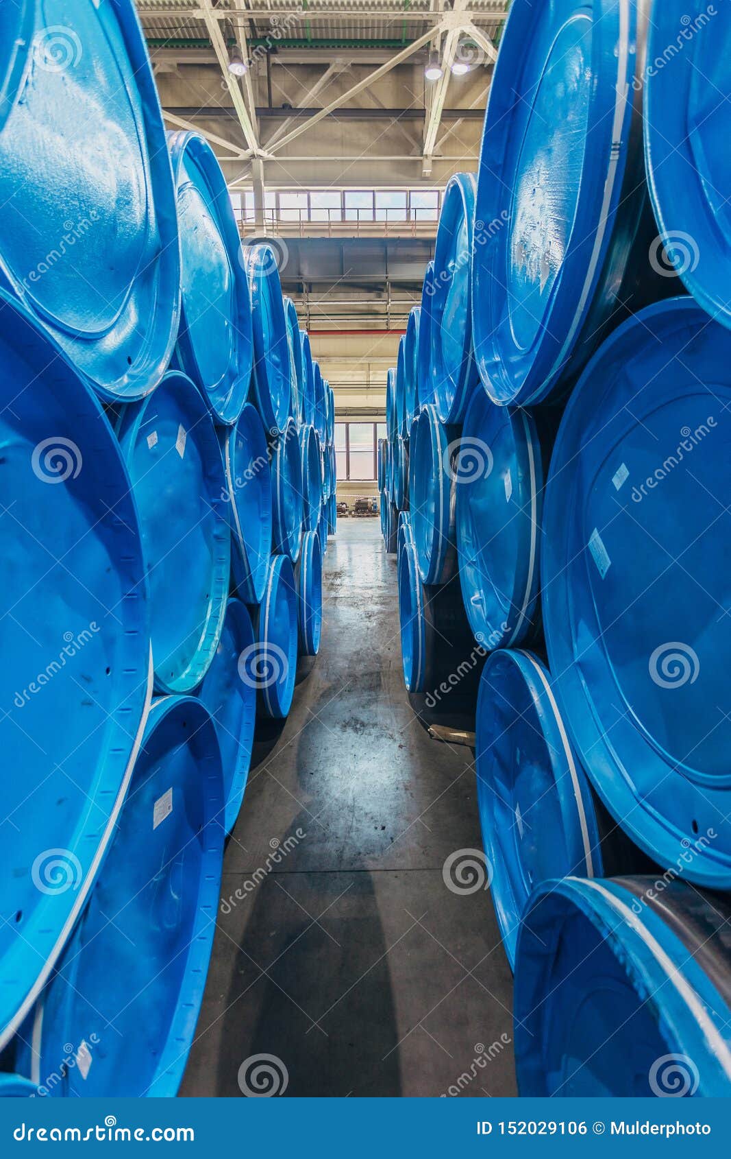 Steel Pipes Covered with Blue Caps in Warehouse Stock Photo - Image of ...