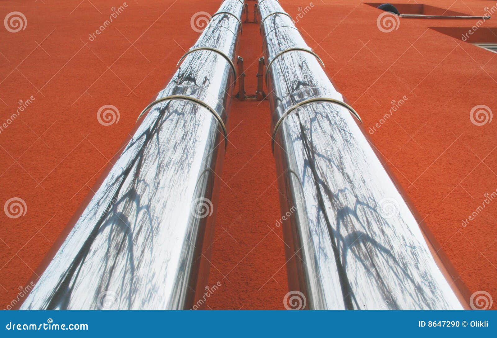 Steel pipes on a red wall stock photo. Image of reflection - 8647290