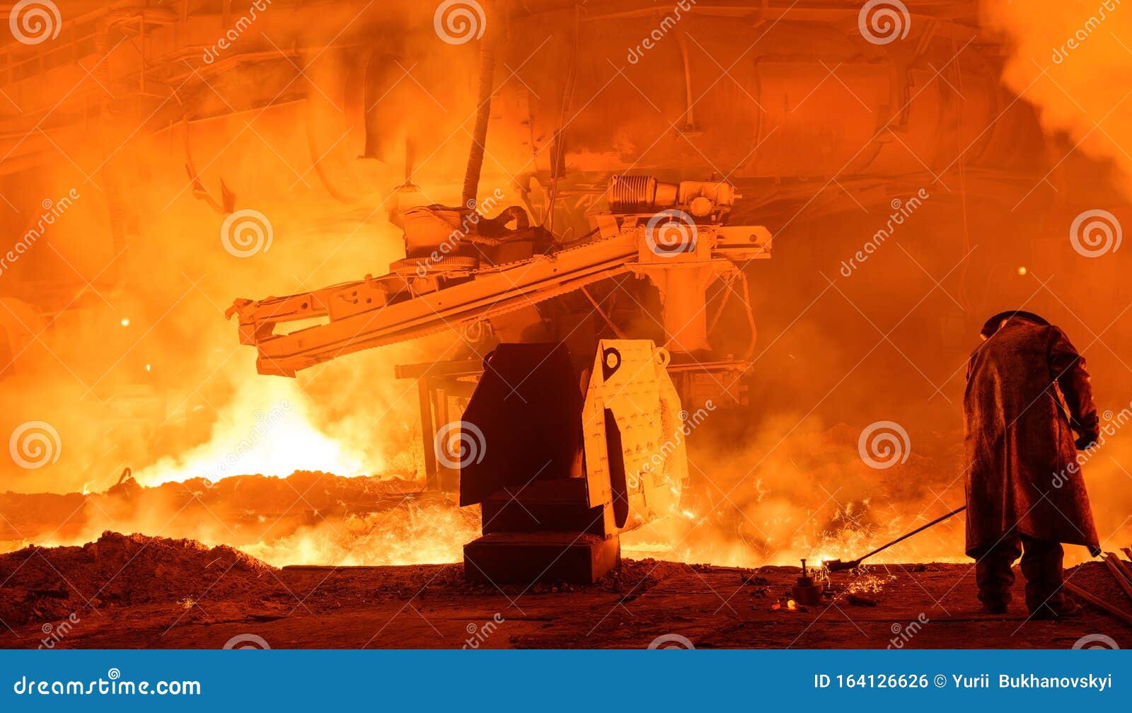 Steelworker Near a Blast Furnace with Sparks. Foundry. Heavy Industry ...