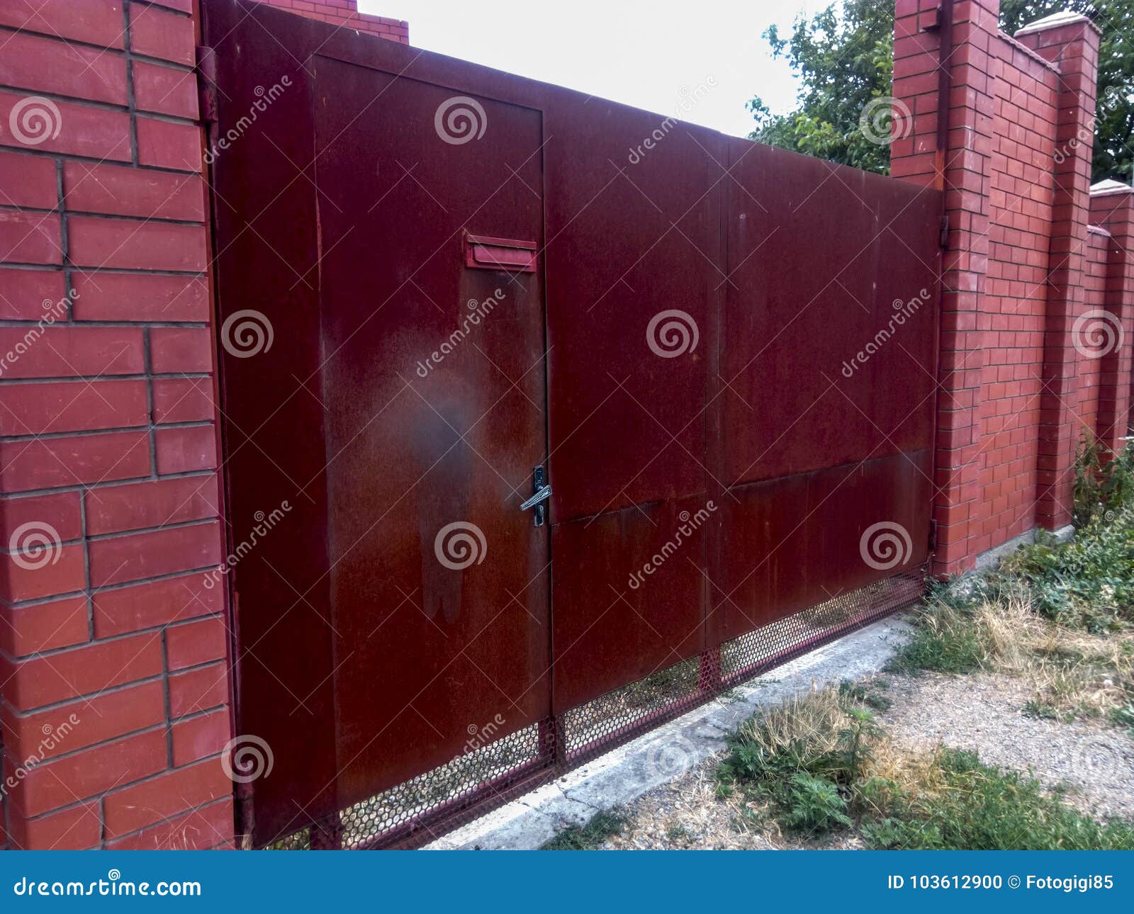 Steel Rusty Gates and a Red Brick Fence. Stock Photo - Image of lush ...