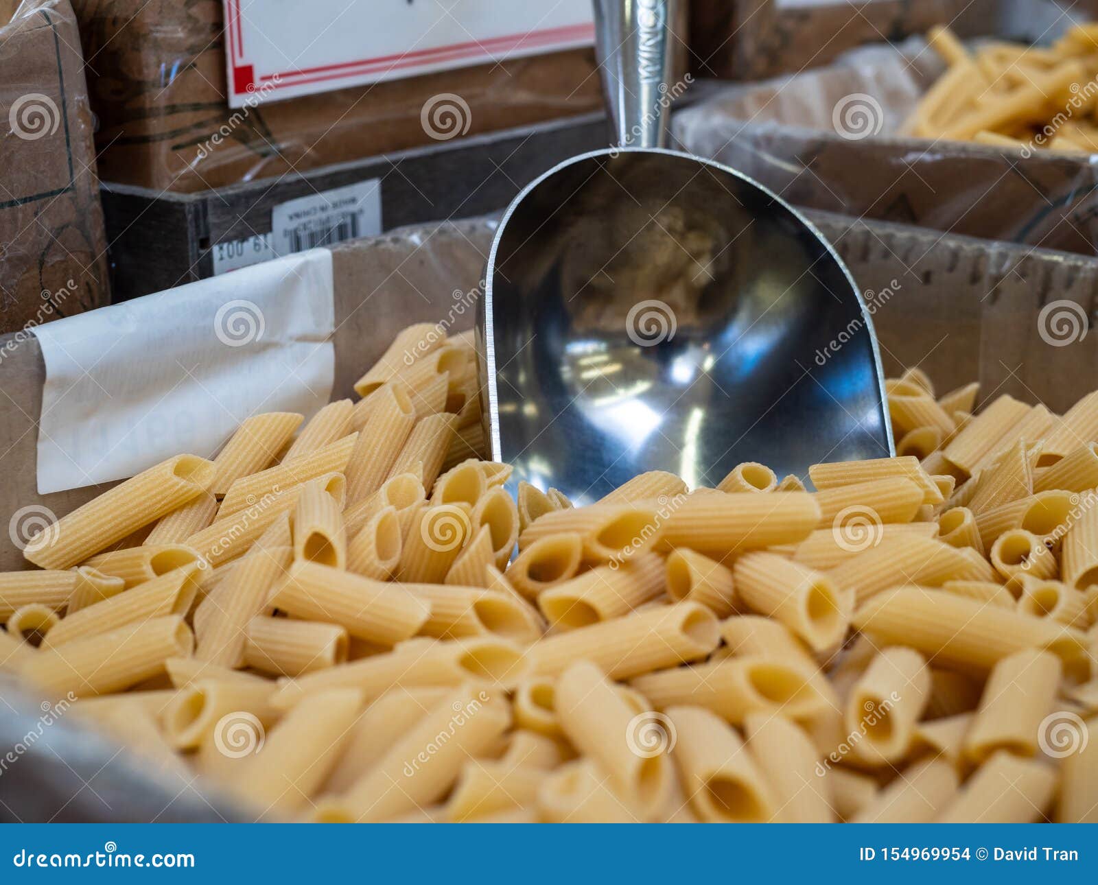 Steel Scoop Resting in Large Box of Penne Pasta Stock Photo - Image of ...