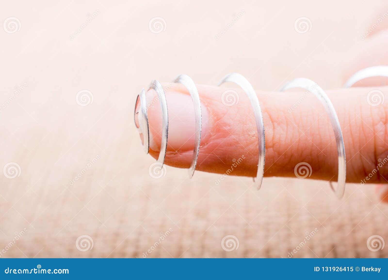 Steel Spiral Spring in a Finger on Textured Background Stock Image ...