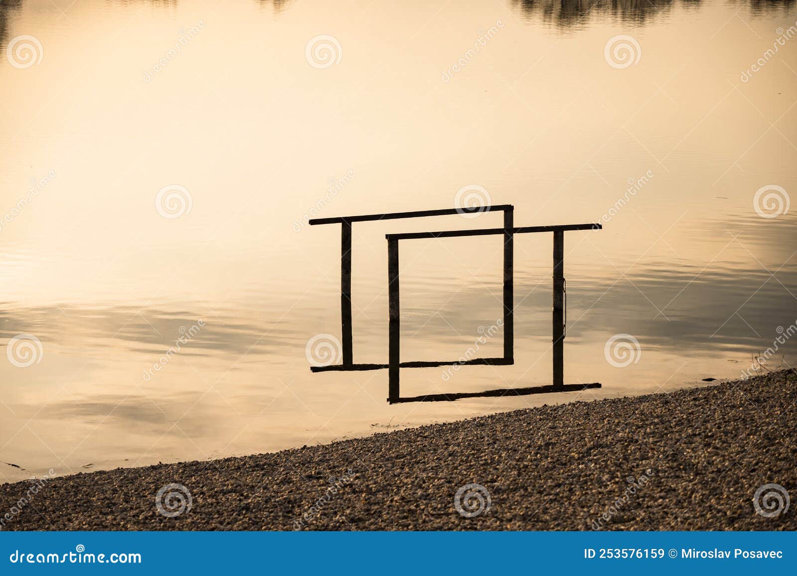 Steel Structures Standing in the Shallow Water, Reflected in the ...
