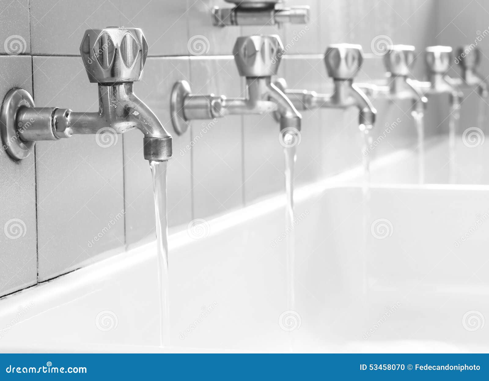 Steel Taps into a Large Bathroom in the Community Stock Photo - Image ...
