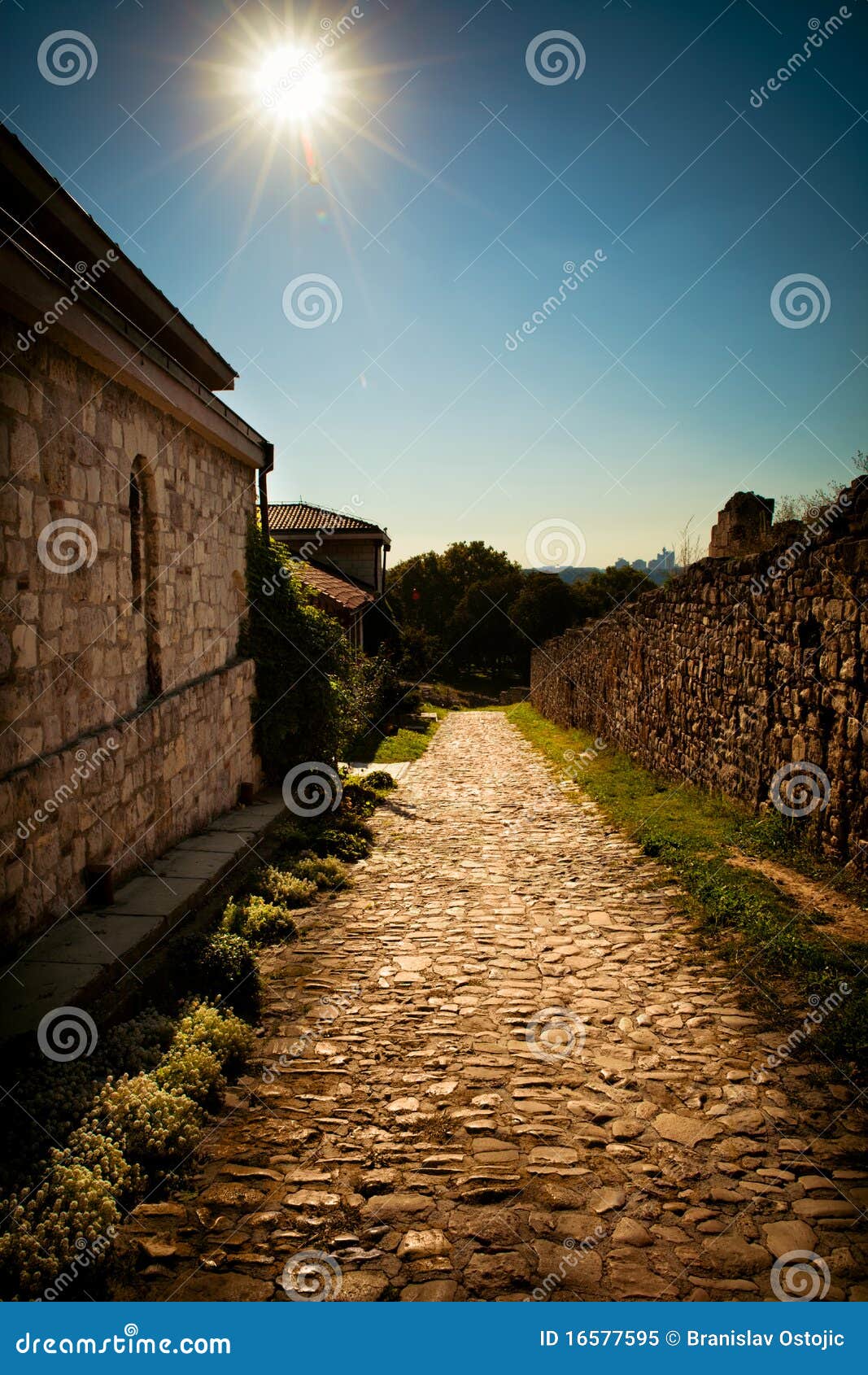 Cobblestone Path With Street Light Lamp Near Wall Of Stone Brick ...