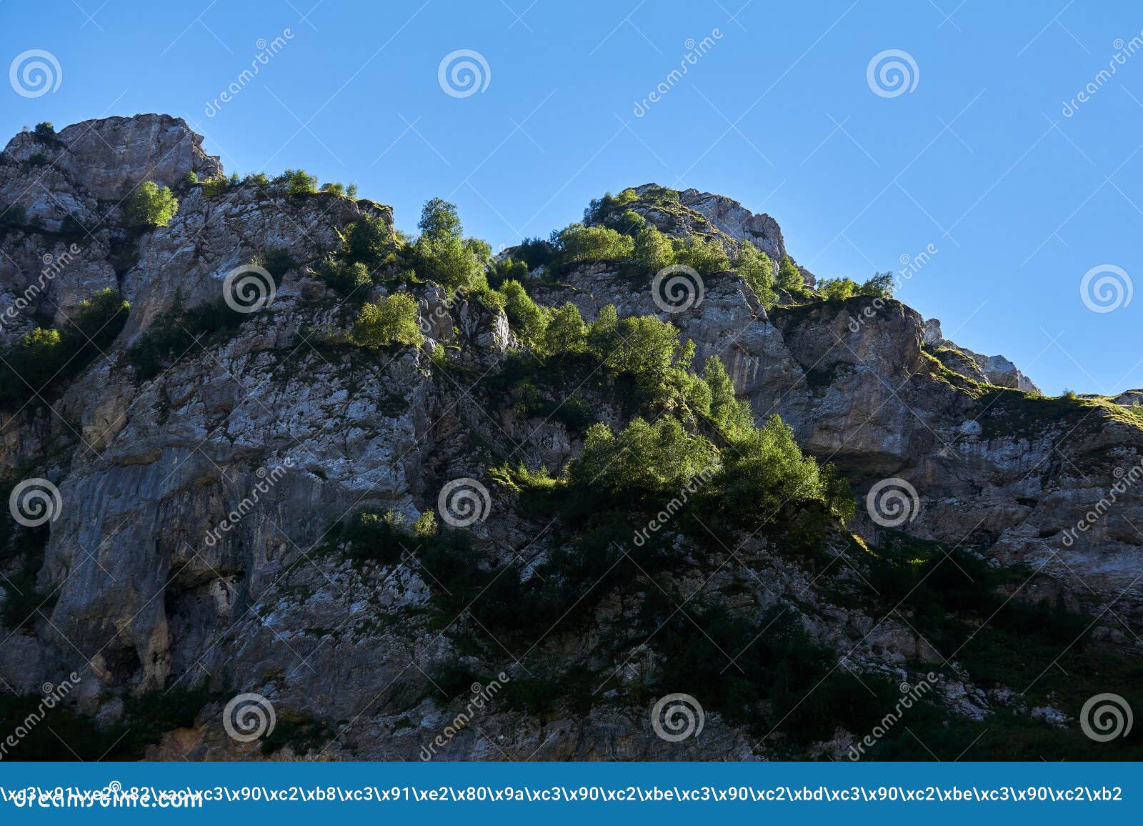 Steep Mountain Ledges, Overgrown with Vegetation, Against the Sky Stock ...