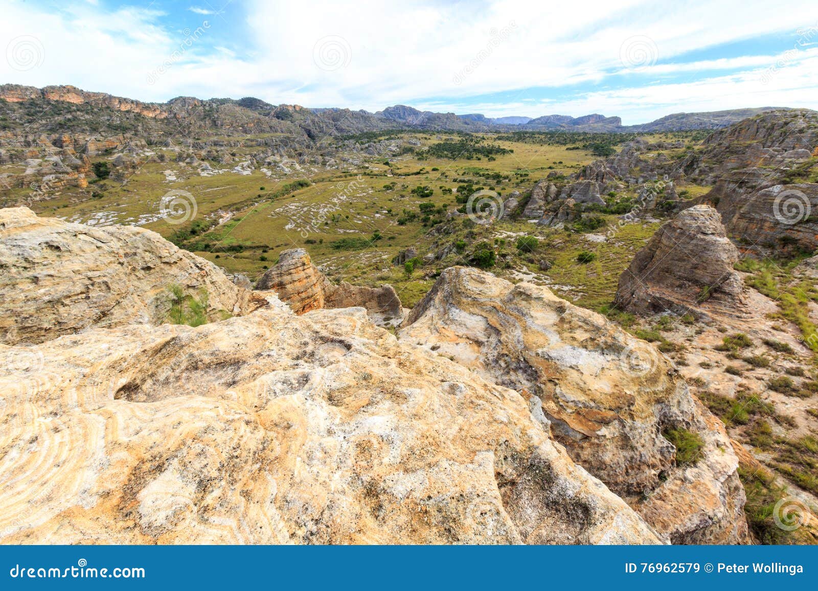 Steep Sharp Rocks Surrounding a Valley with Trees and Grassland Stock ...