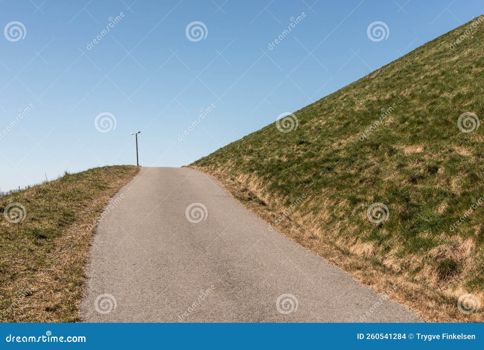 Steep Uphill Road with Grass Fields on Each Side.. Stock Photo - Image ...