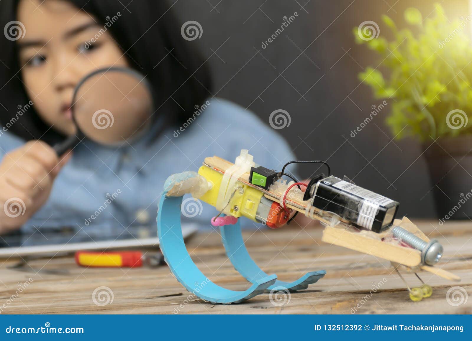 STEM Education Concept.a Student Holding a Magnifying Glass Watching ... STEM Education Concept.a Student Holding a Magnifying Glass Watching ...