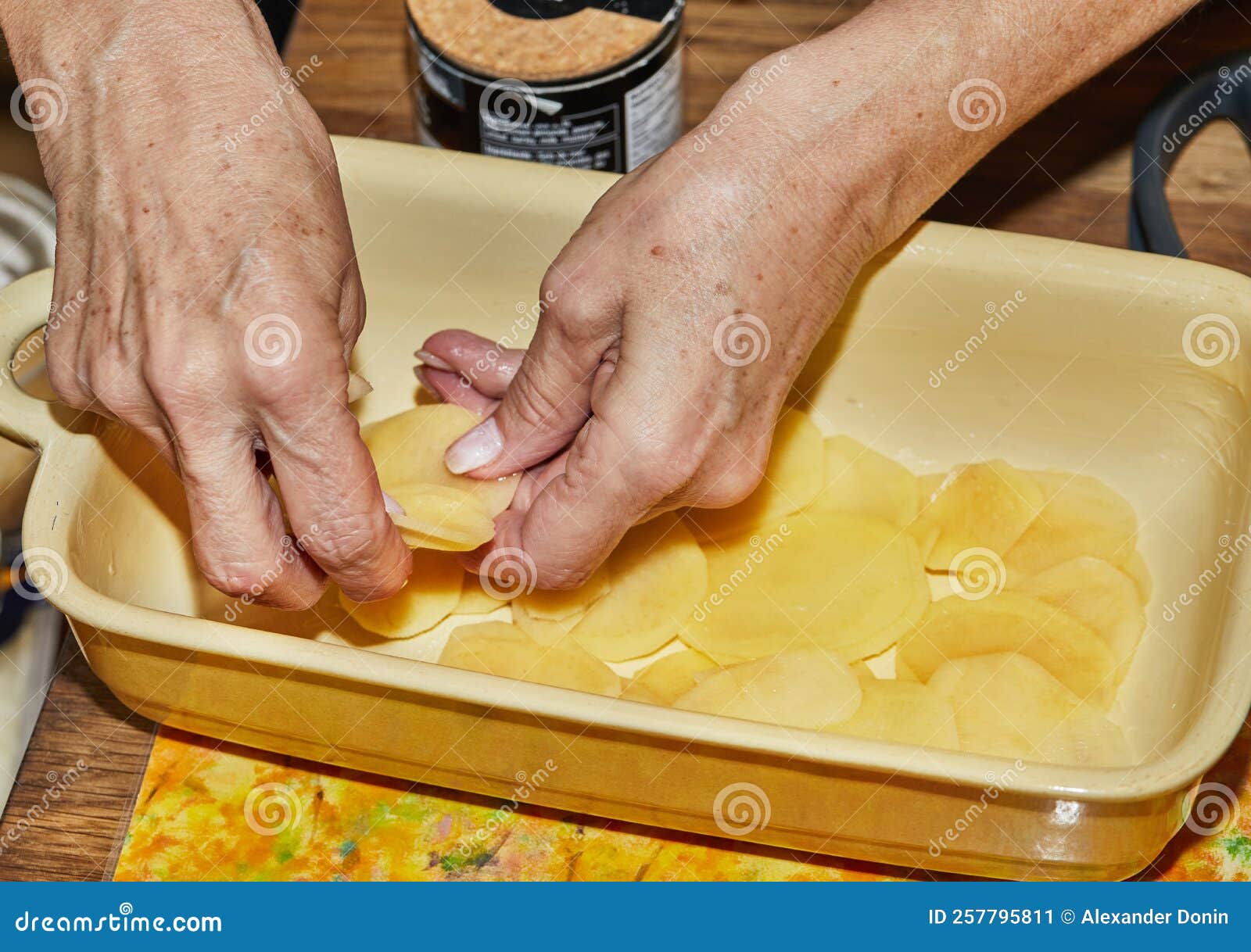 Step-by-step Recipe Of Potato Gratin. Hands Stack Potato Slices To ...