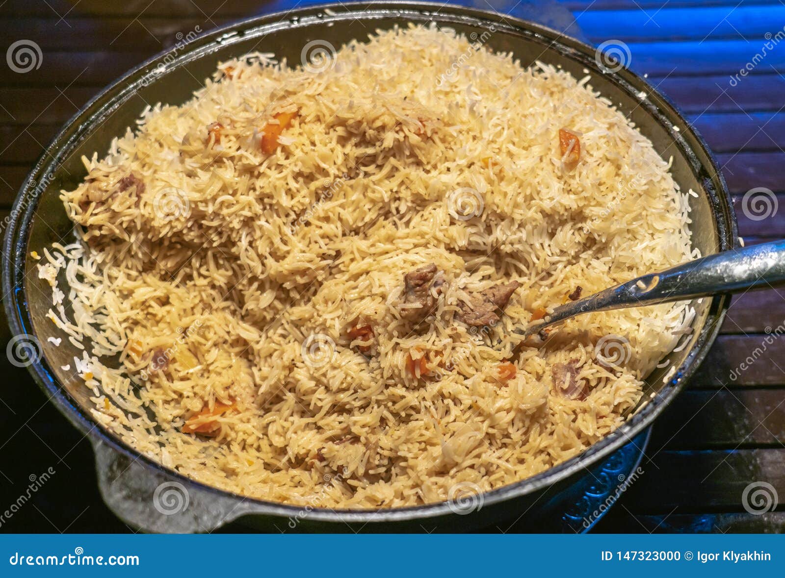 Step-by-step Process of Cooking Pilaf in a Cast Iron Cauldron Stock ...