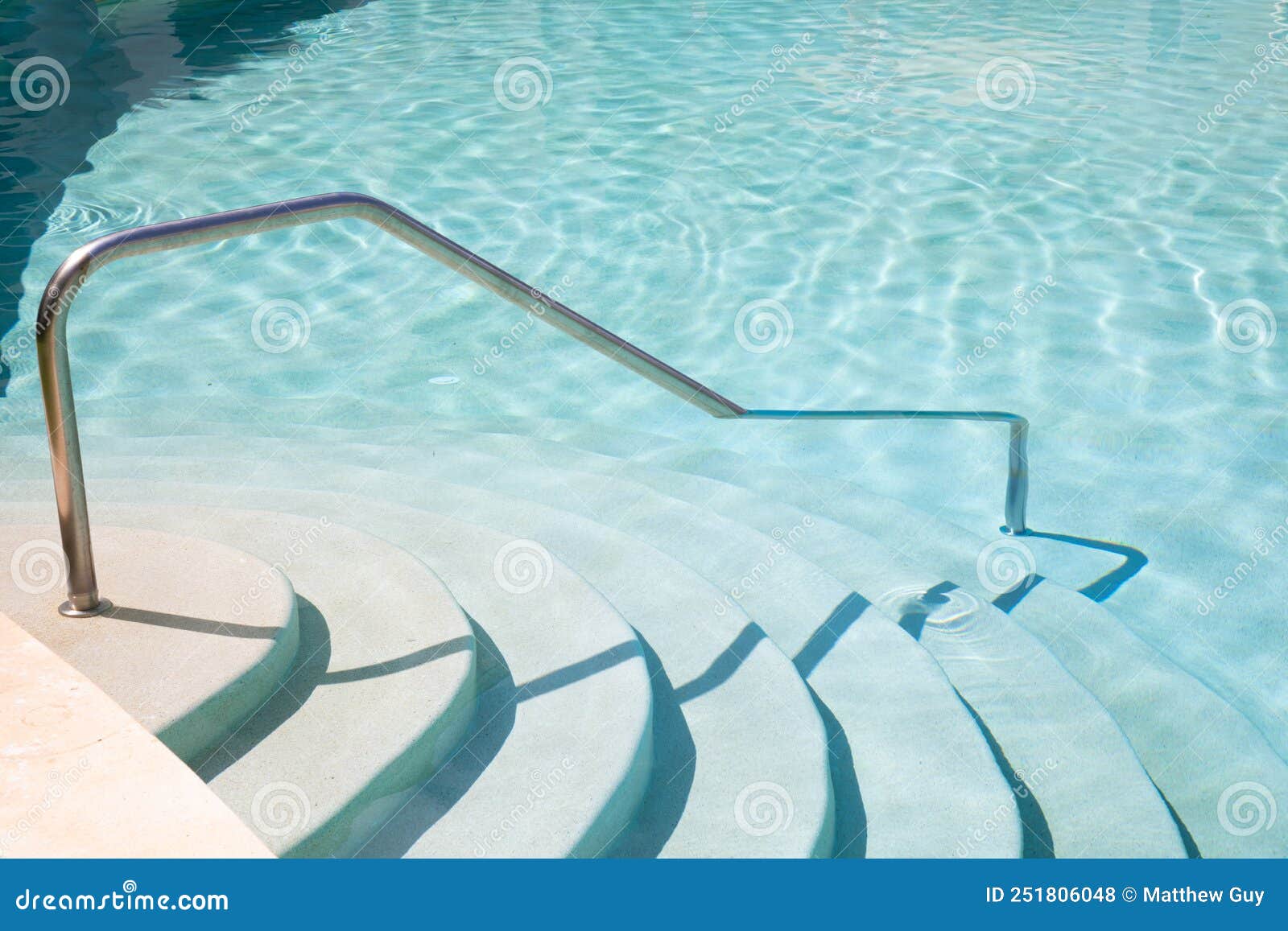 Steps and rail in pool stock photo. Image of slippery - 251806048