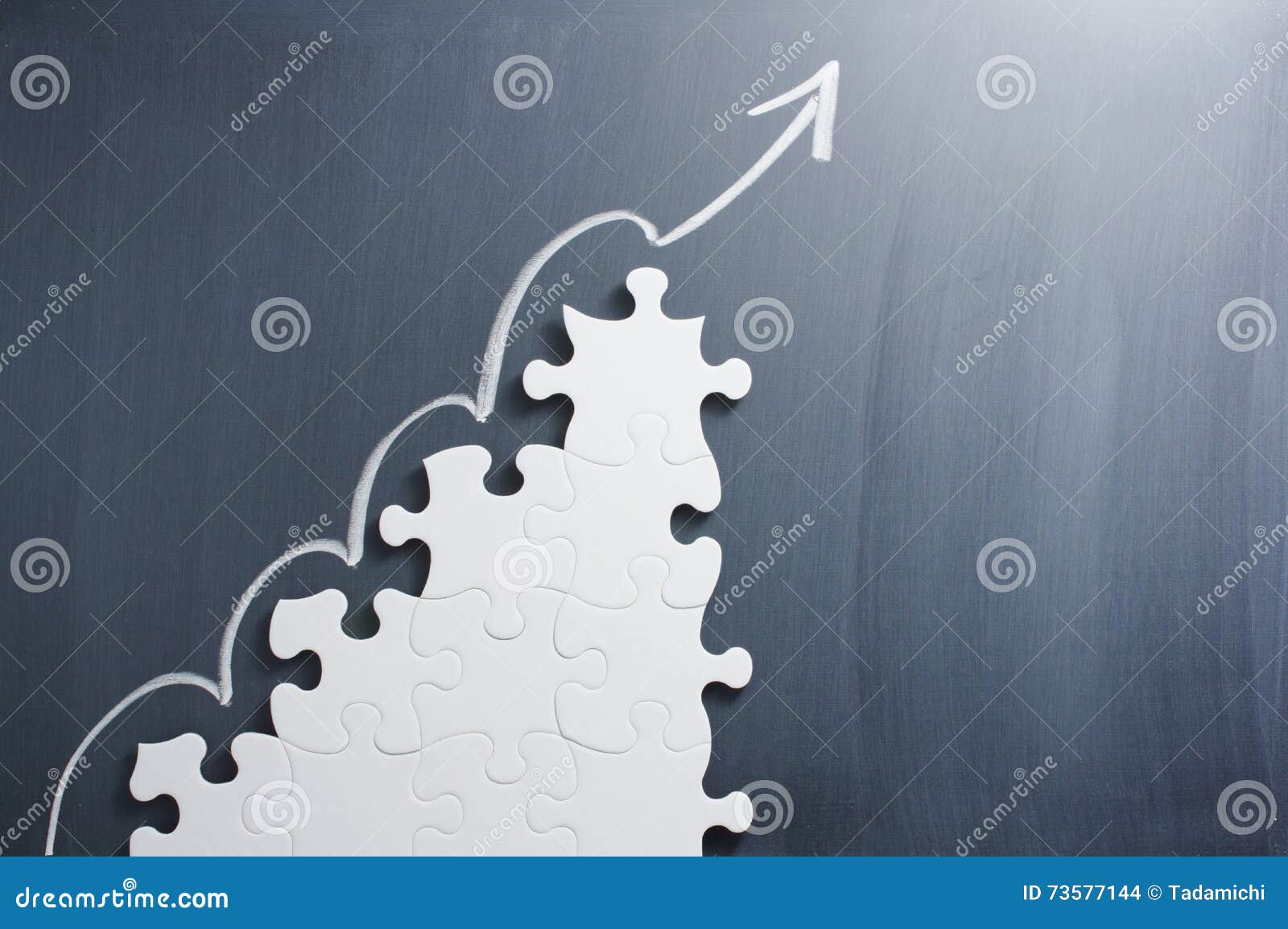 Steps Shaped Jigsaw Puzzle and Up Arrow on Blackboard. Stock Photo ...