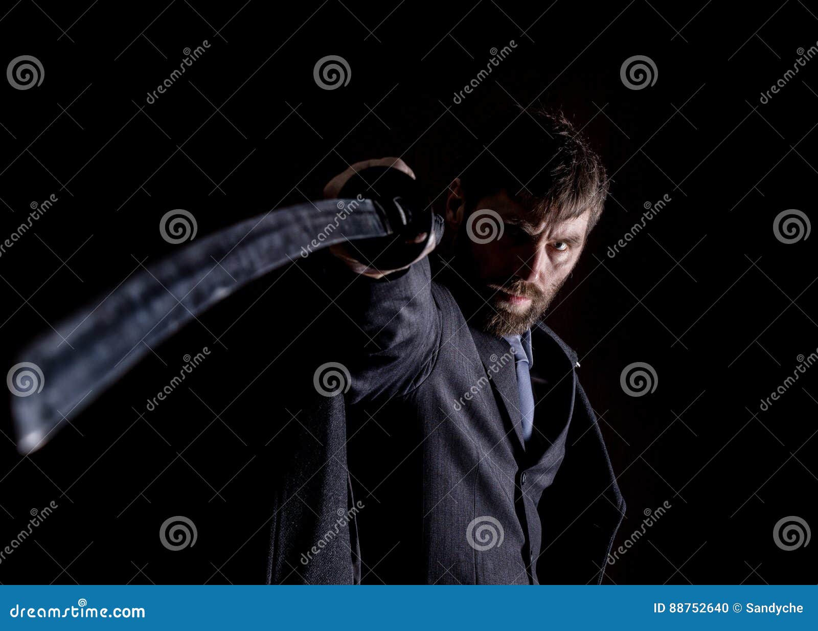 Stern Angry Businessman in a Wool Coat with Sword in Dark Background ...