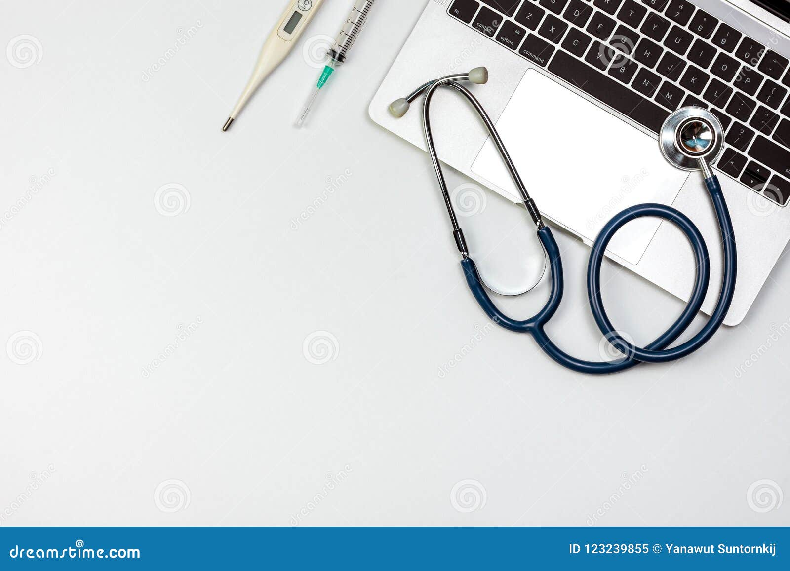 Stethoscope on Laptop Computer with Syringe and Thermometer at Doctor ...