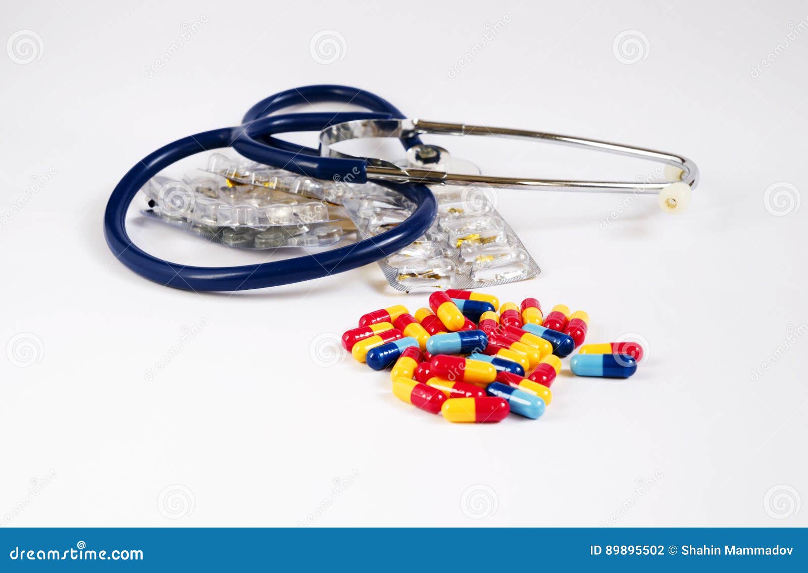 Stethoscope and Medicines in Different Colored Capsules Stock Photo ...