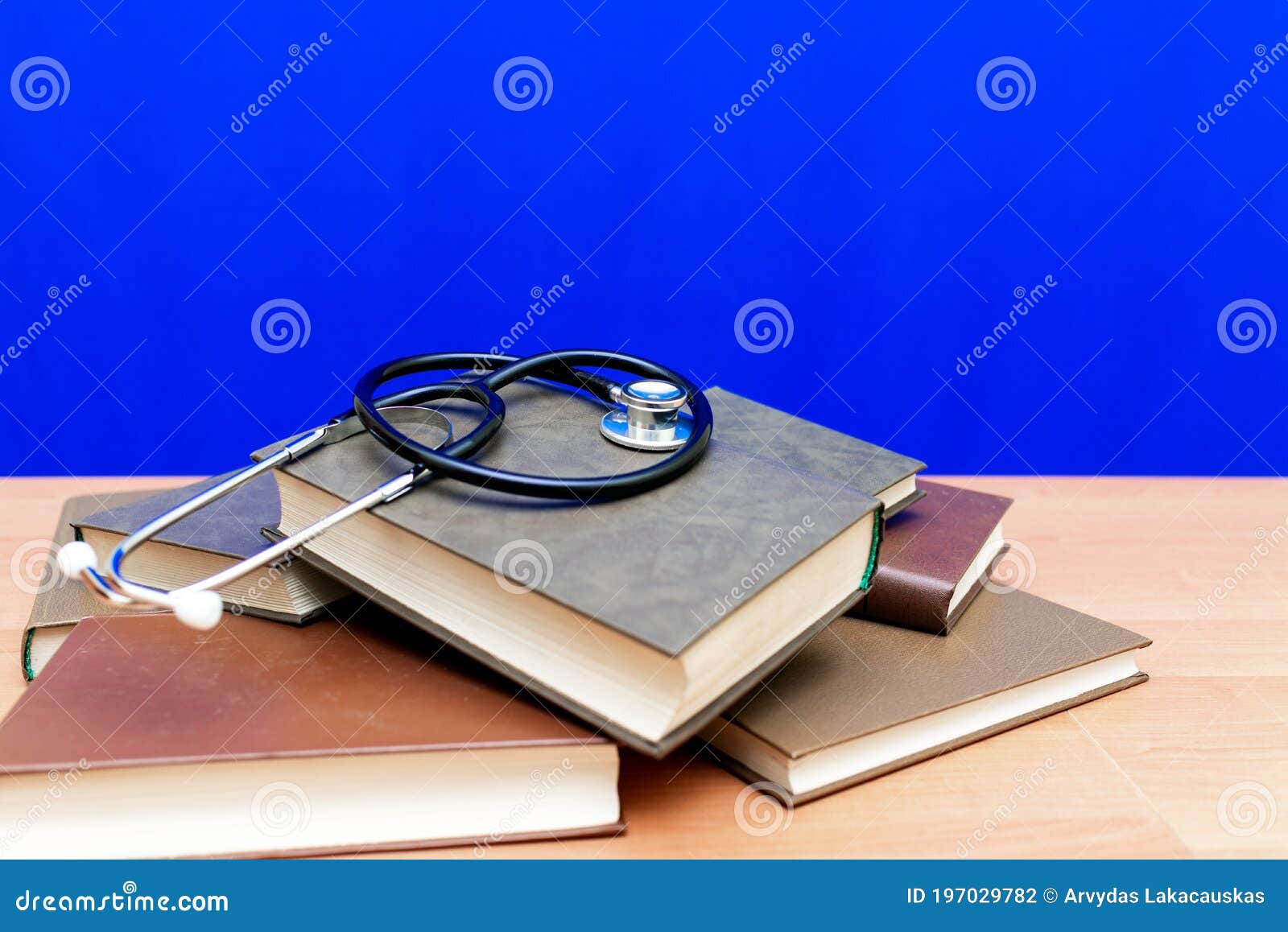 Stethoscope with Stack of Books on Table or Blue Background.Medical ...
