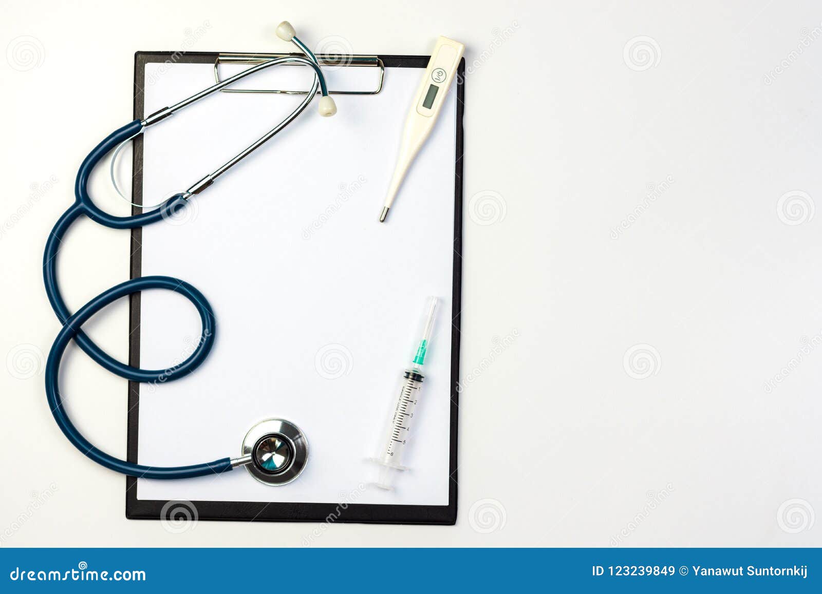 Stethoscope Syringe And Thermometer On Clipboard With Blank Paper