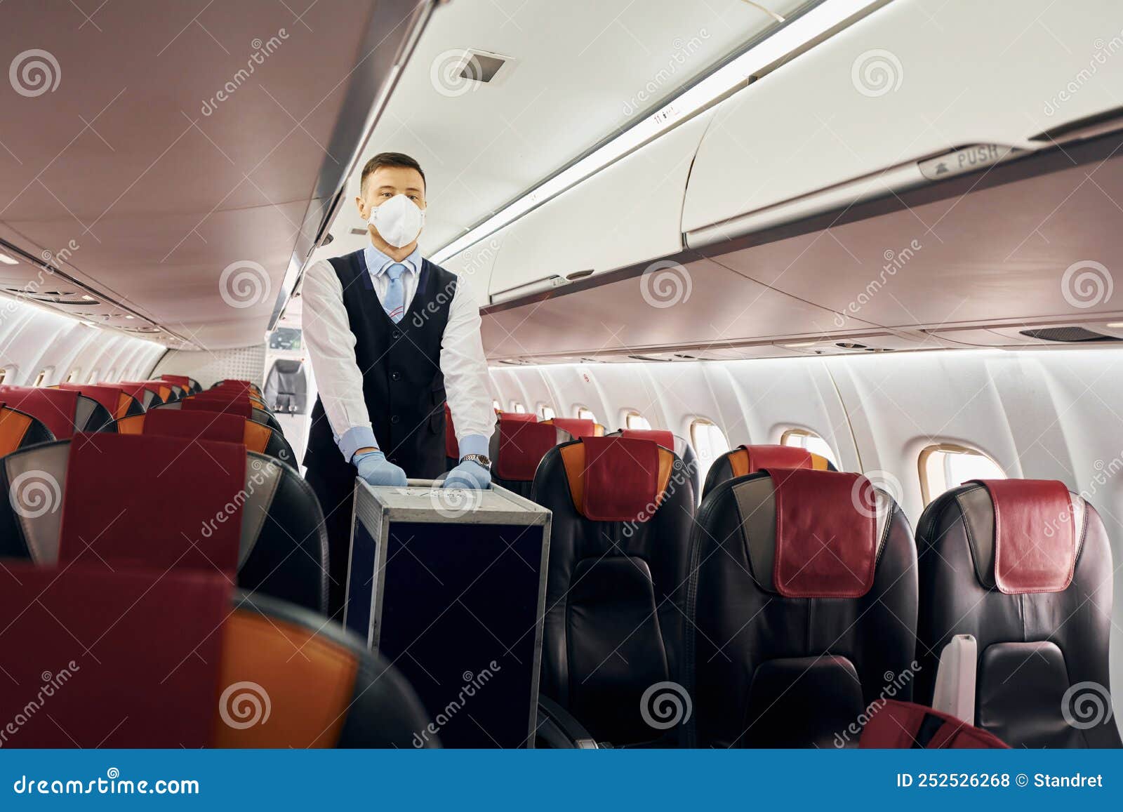 Steward in Uniform is Walks with Luggage Inside of Airplane Stock Photo ...