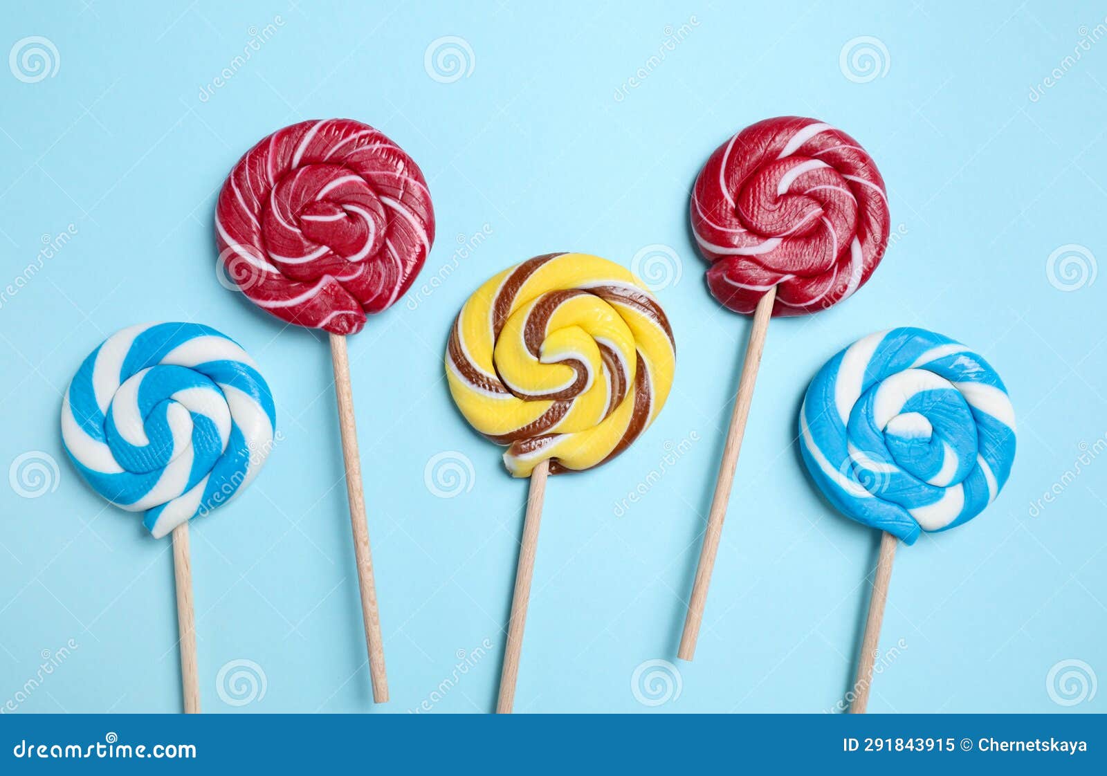 Sticks with Colorful Lollipops on Light Blue Background, Flat Lay Stock ...