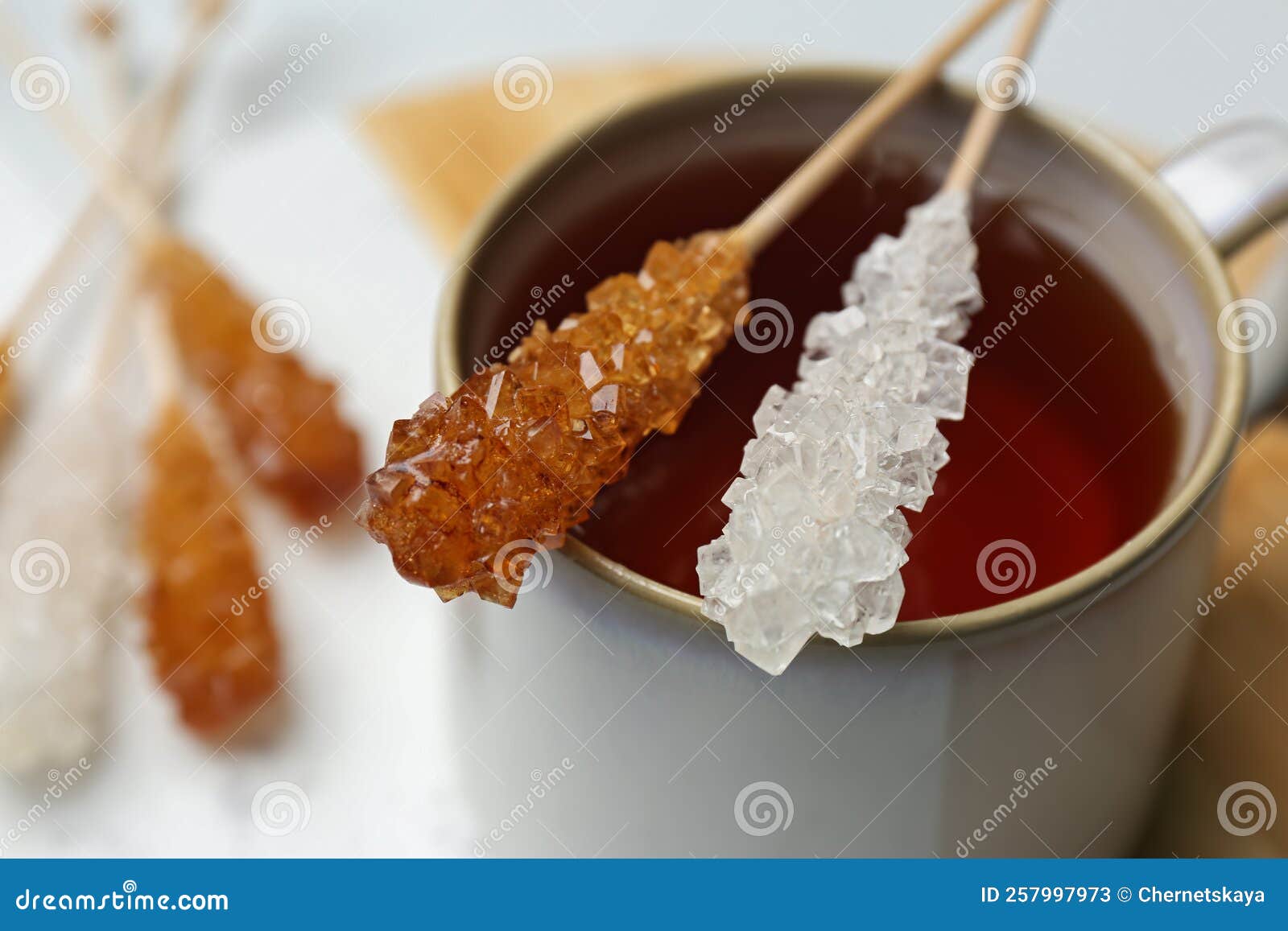 Sticks with Sugar Crystals and Cup of Tea on Table, Closeup Stock Image ...
