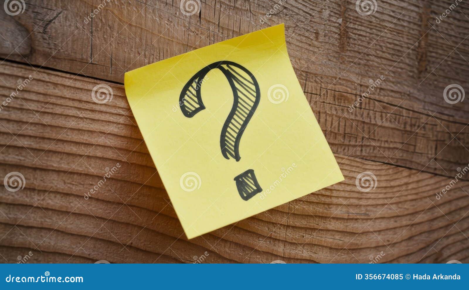 Sticky Note Displaying a Handwritten Question Mark on a Grained Wooden ...