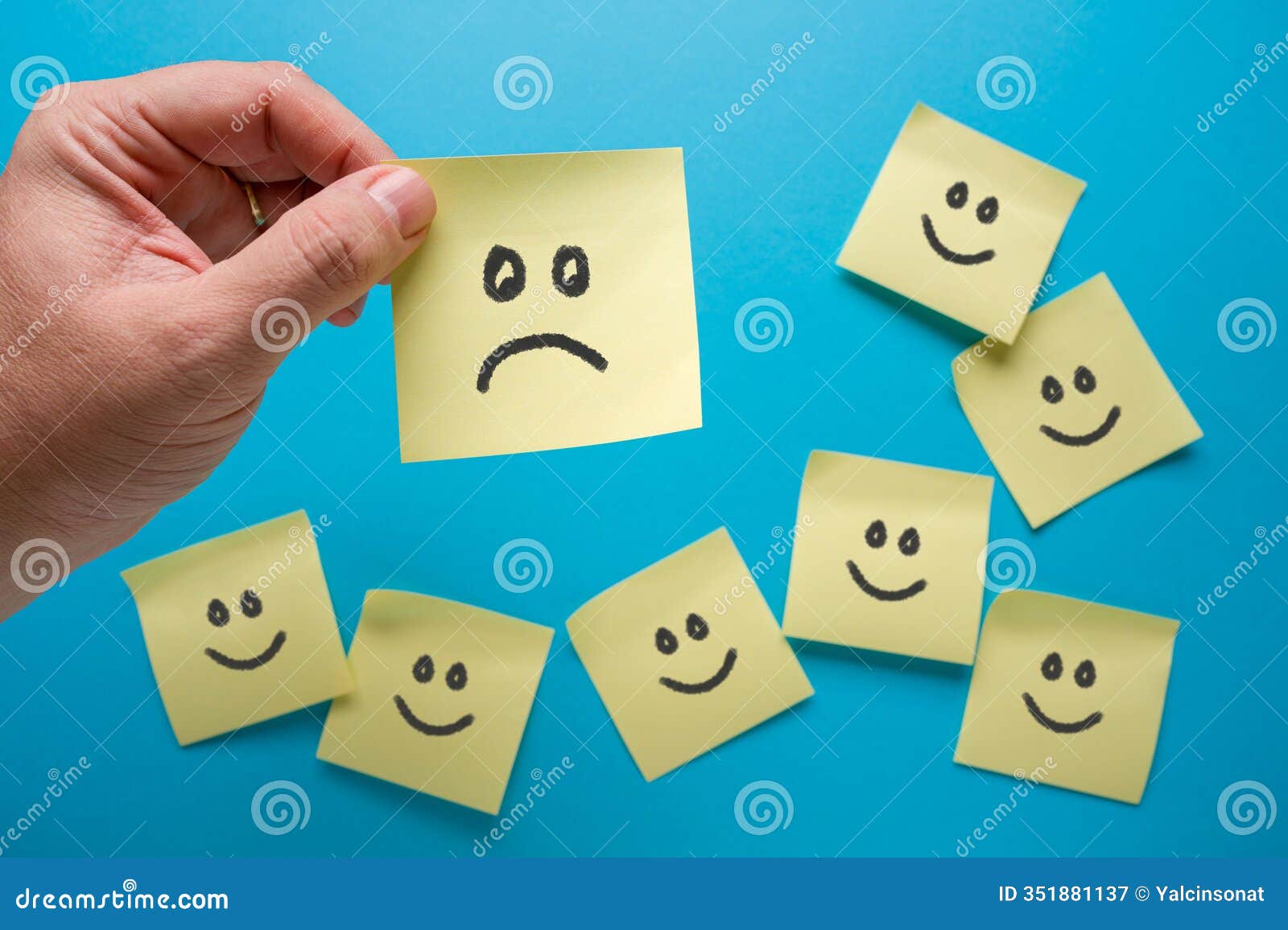 Sticky Note Paper with a Sad Face Icon Surrounded by Smiley Face Icons ...