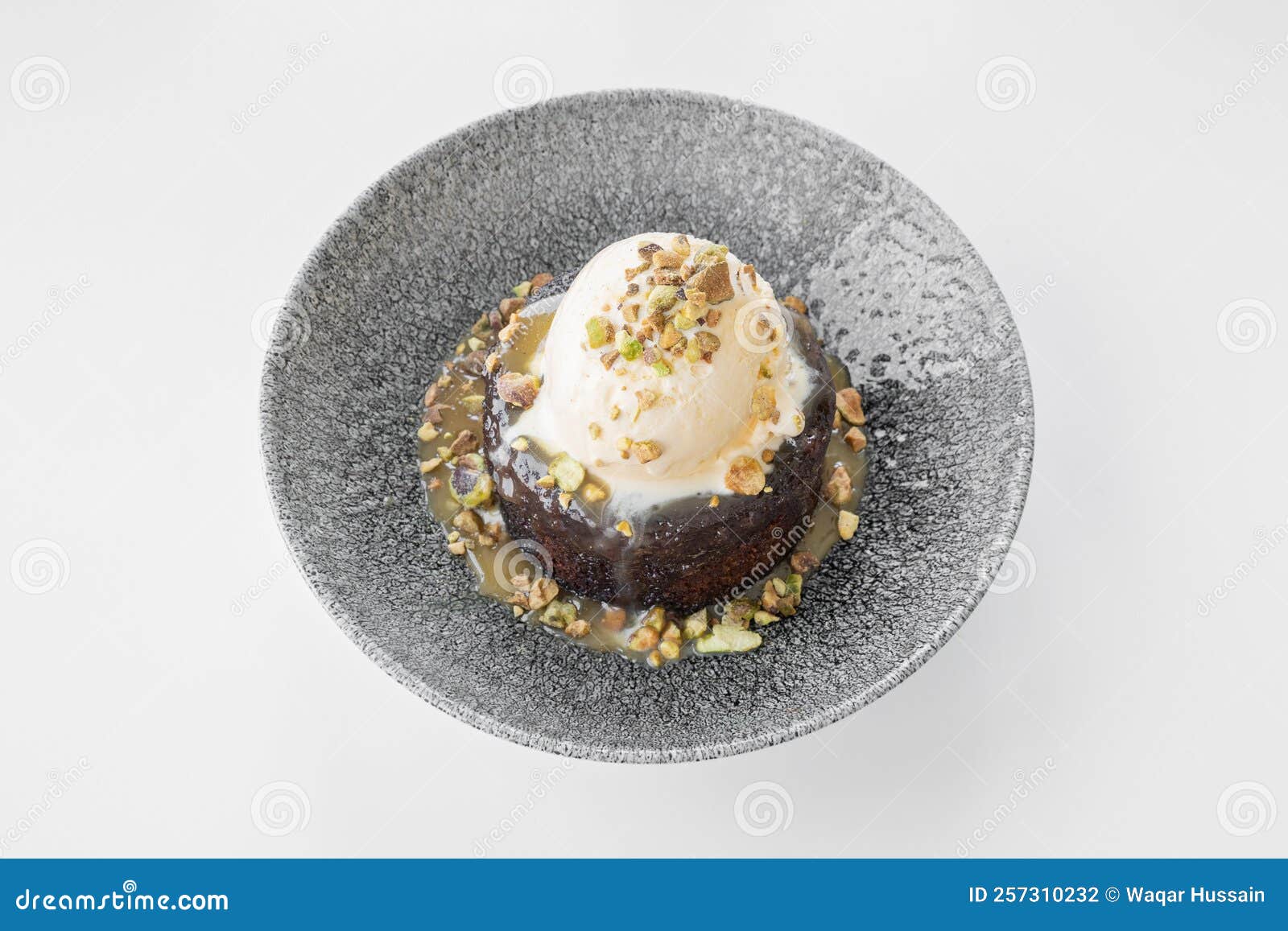 Sticky Toffee Pudding Served in a Dish Isolated on Grey Background Side ...