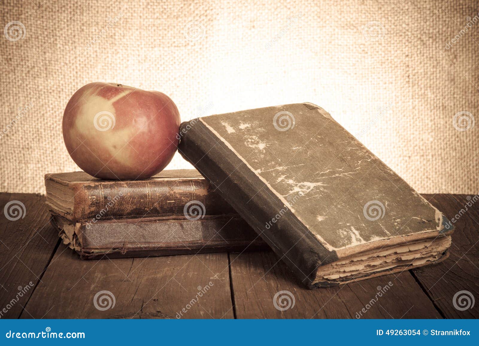 Still Life with Apple and a Stack of Old Books on Old Wooden Tab Stock ...