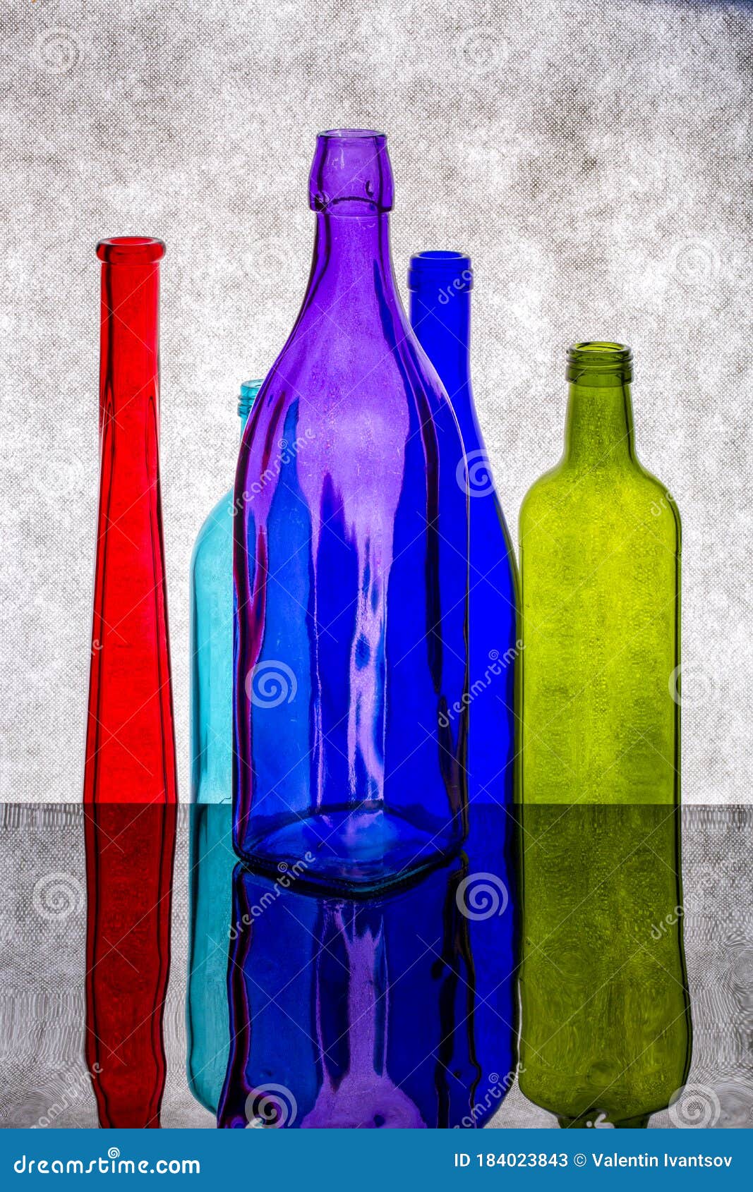 Still Life with Colored Bottles on a Reflective Surface Stock Image ...