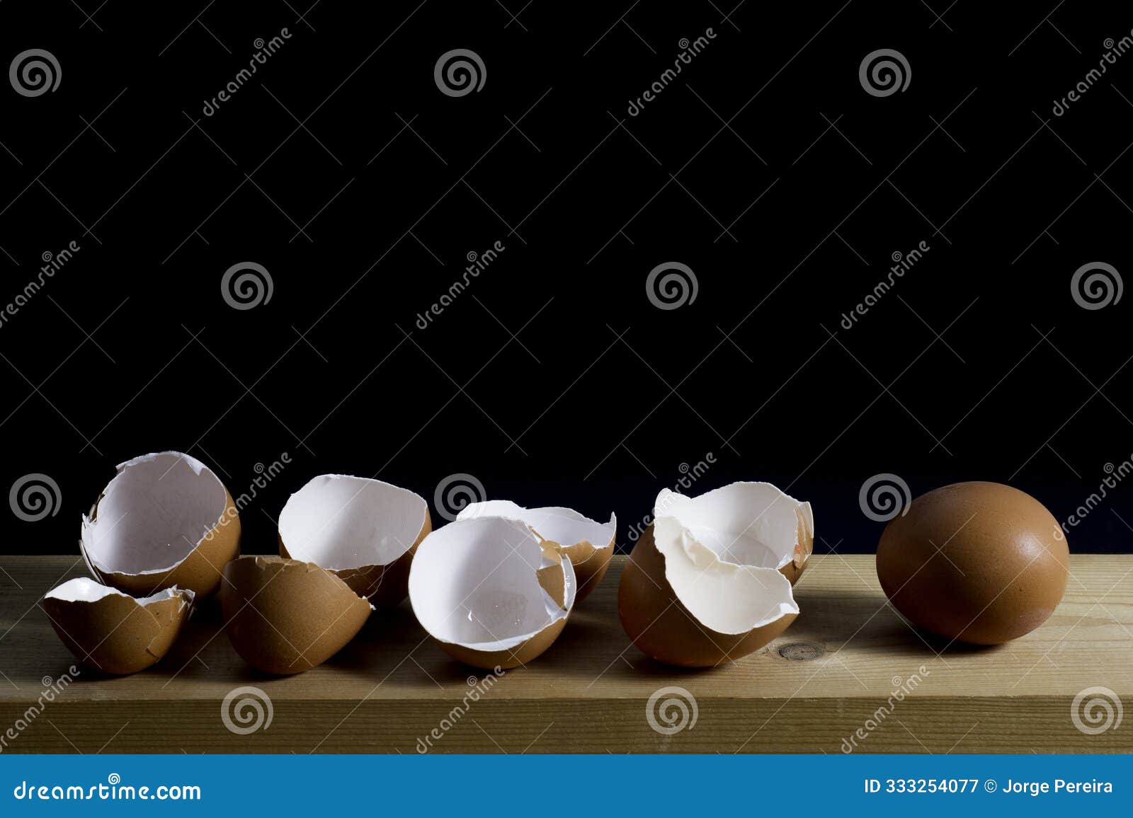 Next Egg To Break - Five Eggs on Table Against Black Background Stock ...