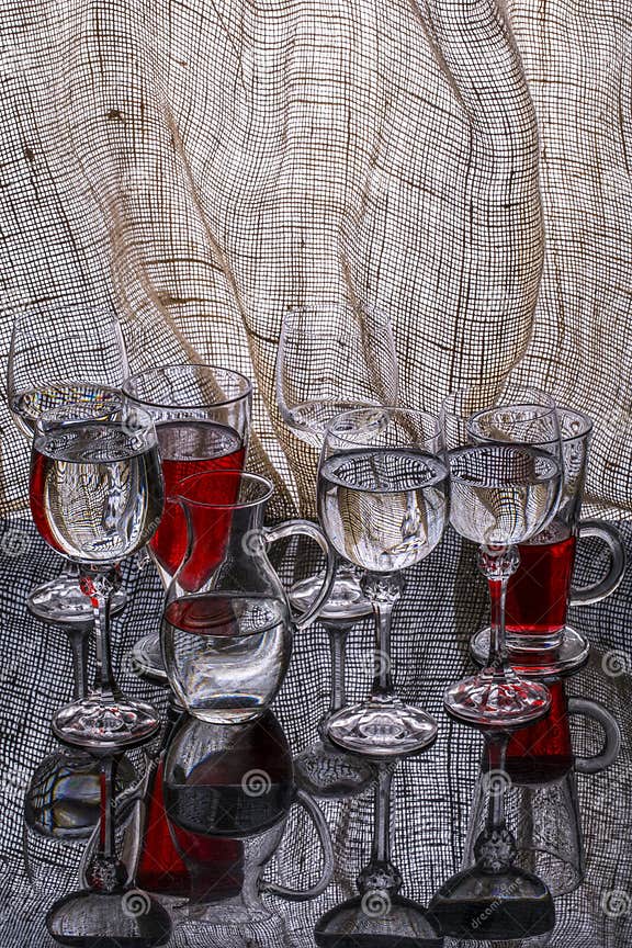 Still Life with Glasses with Liquid on the Reflective Surface Stock ...