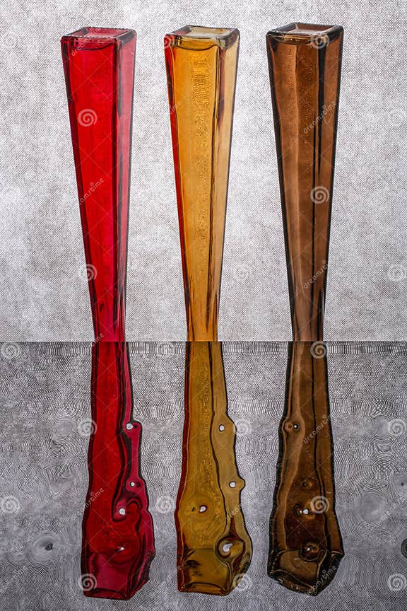 Still Life with Inverted Colored Bottles on a Reflective Surface Stock ...