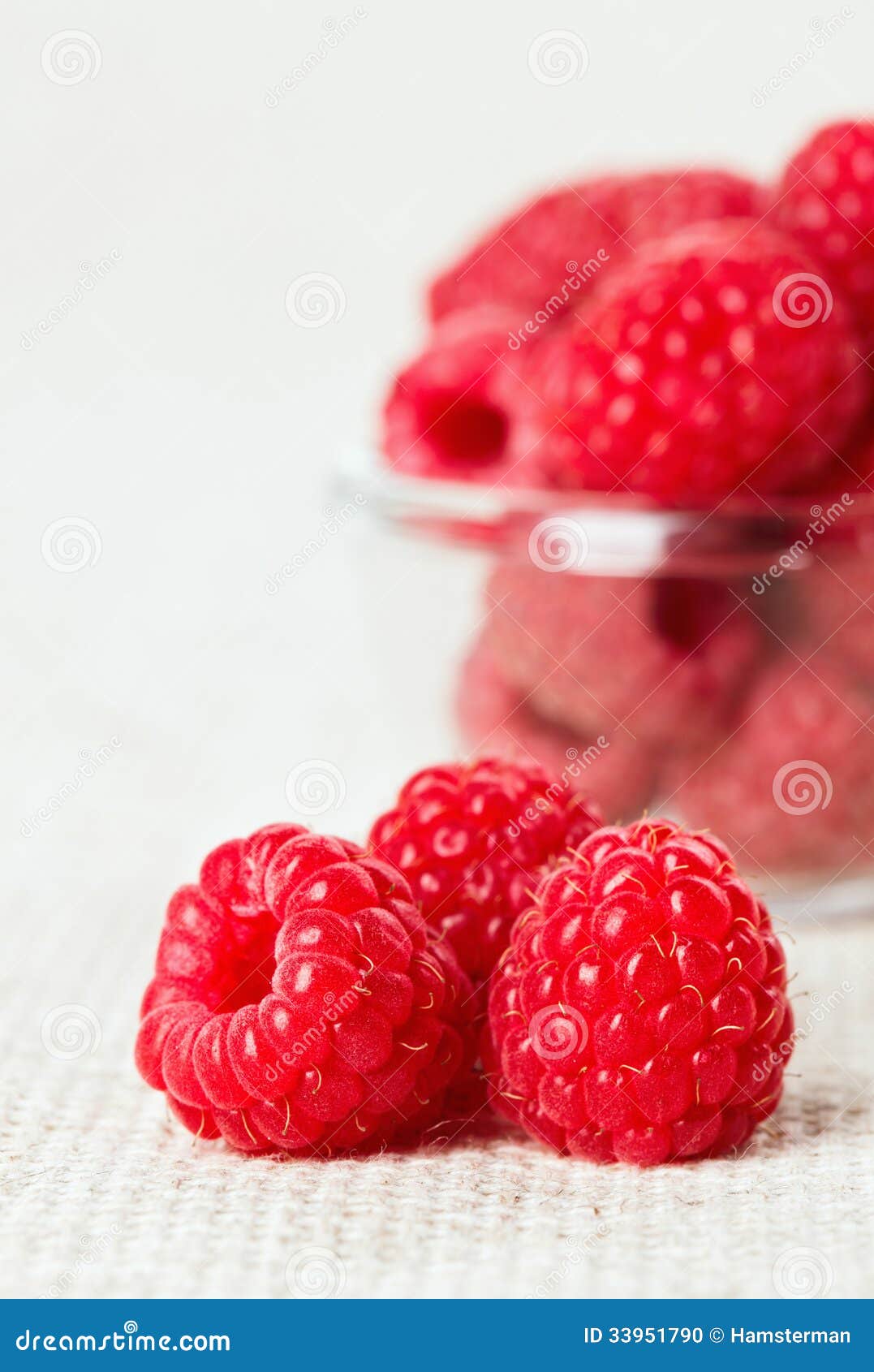 Still Life with Red Raspberry and Glass Bowl on Gray Linen Stock Photo ...