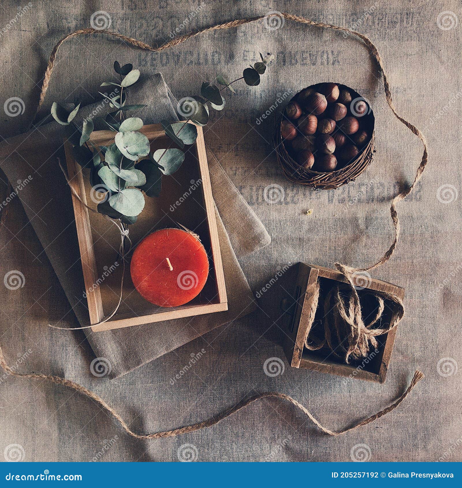 Still Life in Retro Style with Candles, Eucalyptus, Hazelnuts and Plait ...