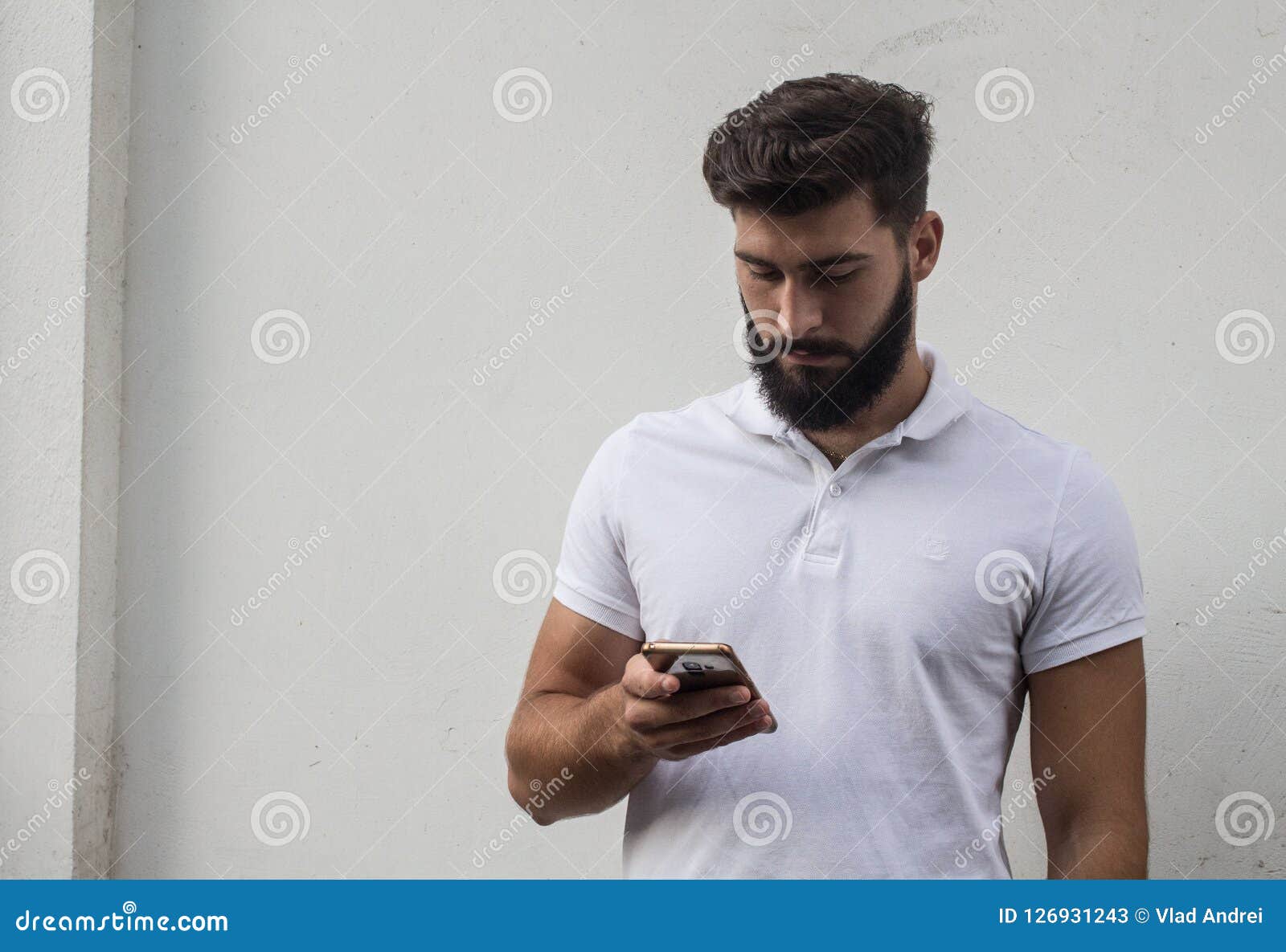 Man Looking at Mobile Phone Stock Image - Image of beard, white: 126931243